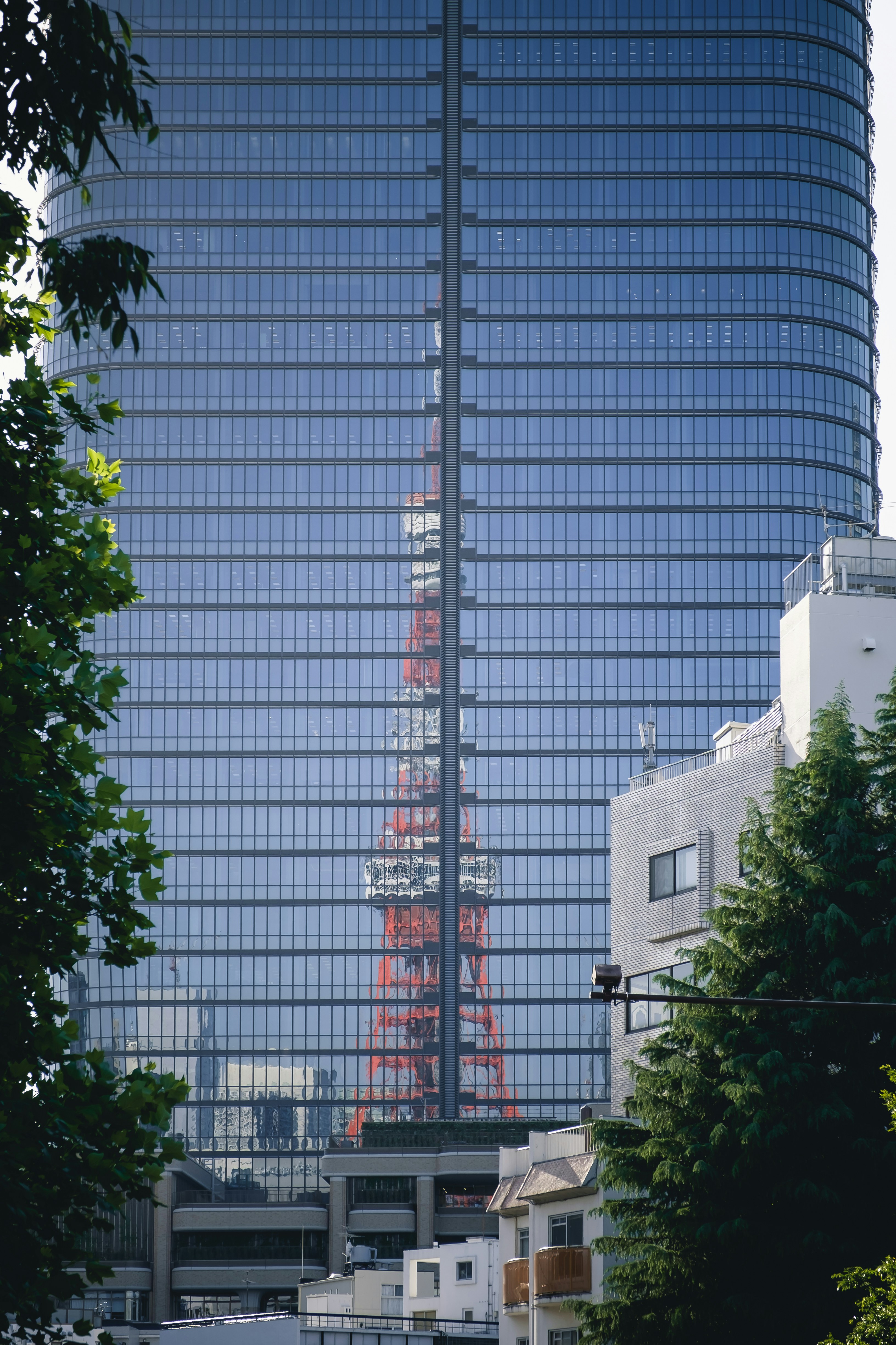 The tokyo tower reflects in a skyscraper's windows. photo – Free ...