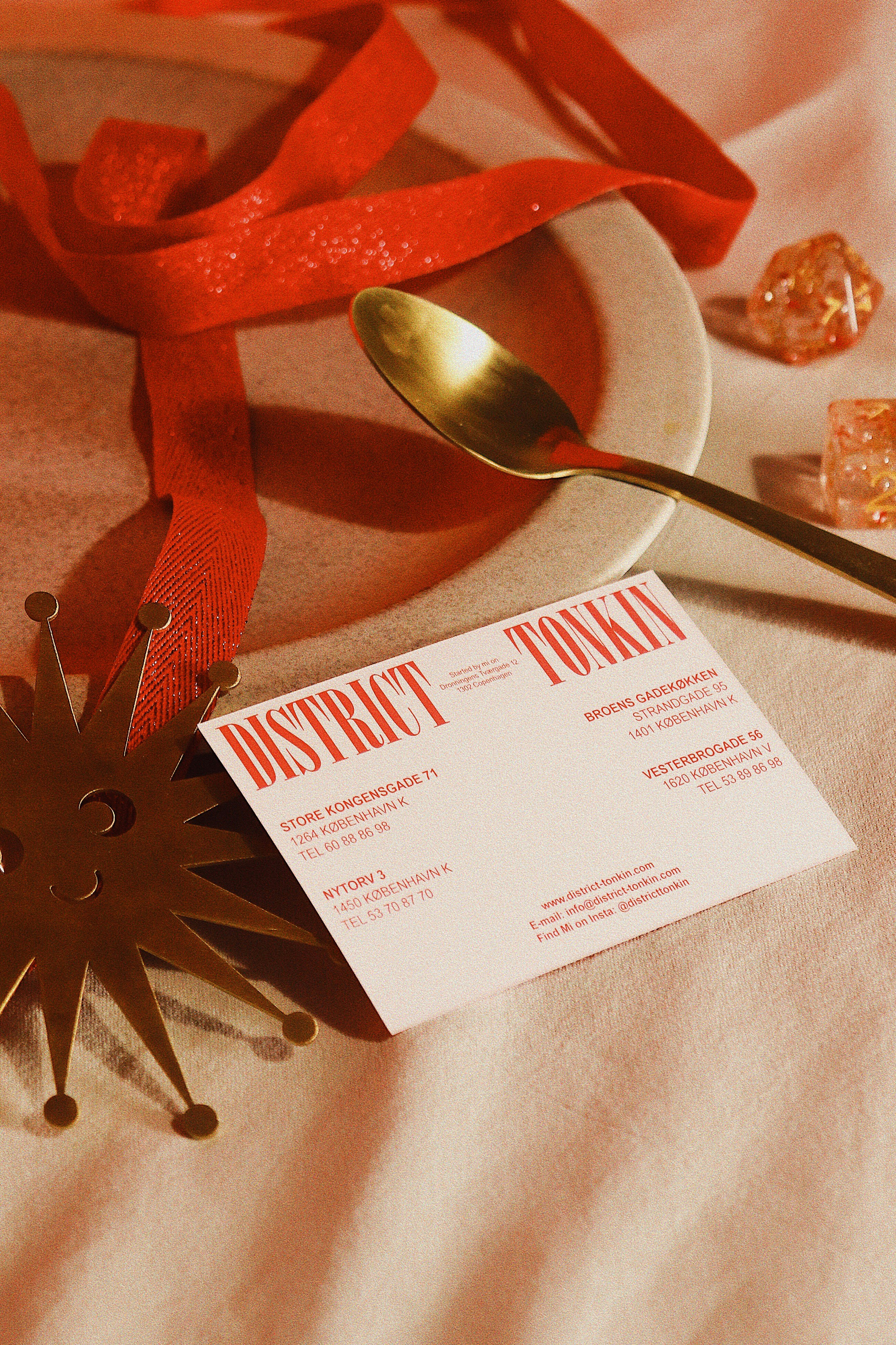 A business card is near a plate with a spoon. photo – Free Paper Image ...