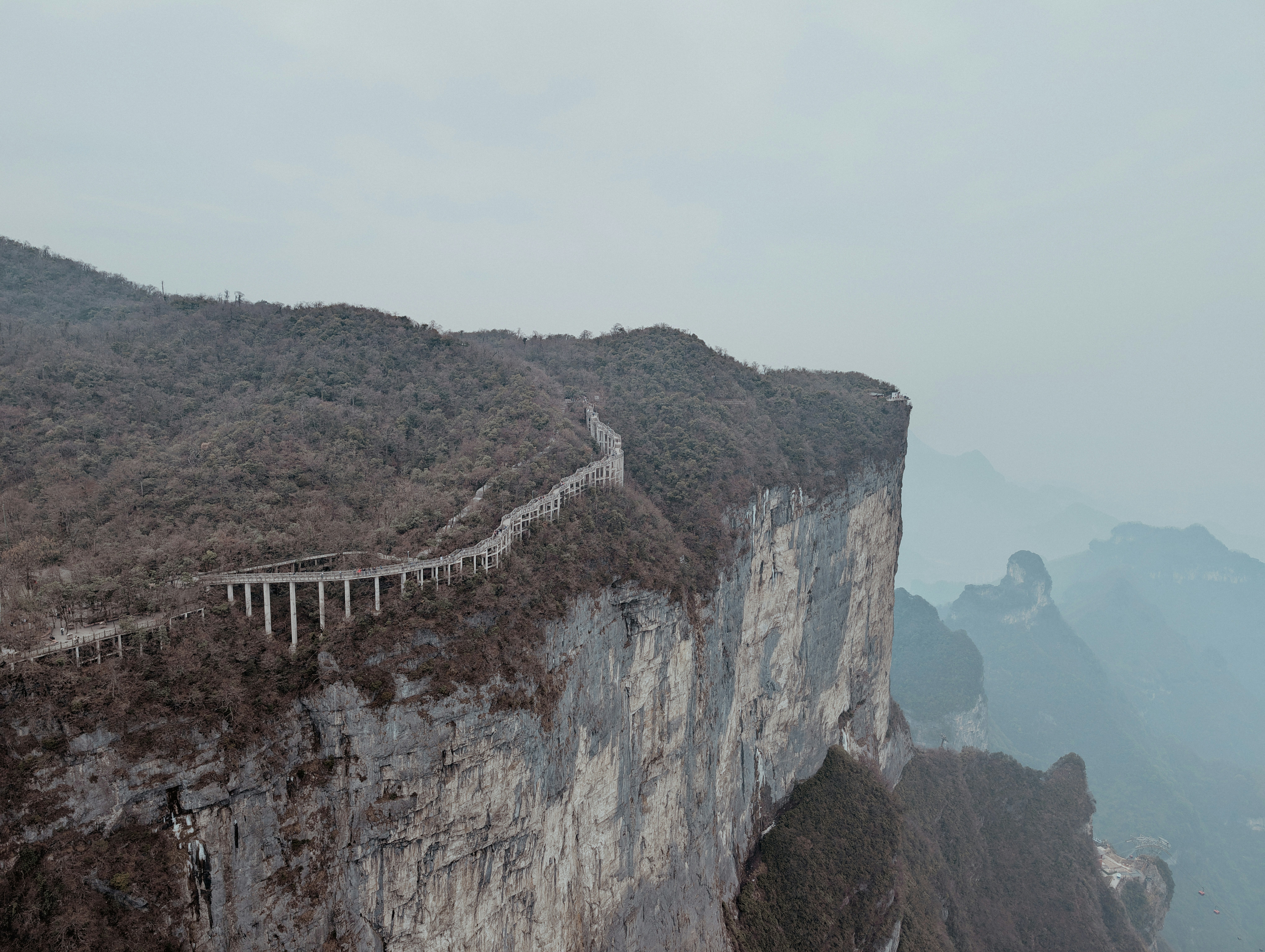 A cliffside road curves along the mountain's edge. photo – Free China ...