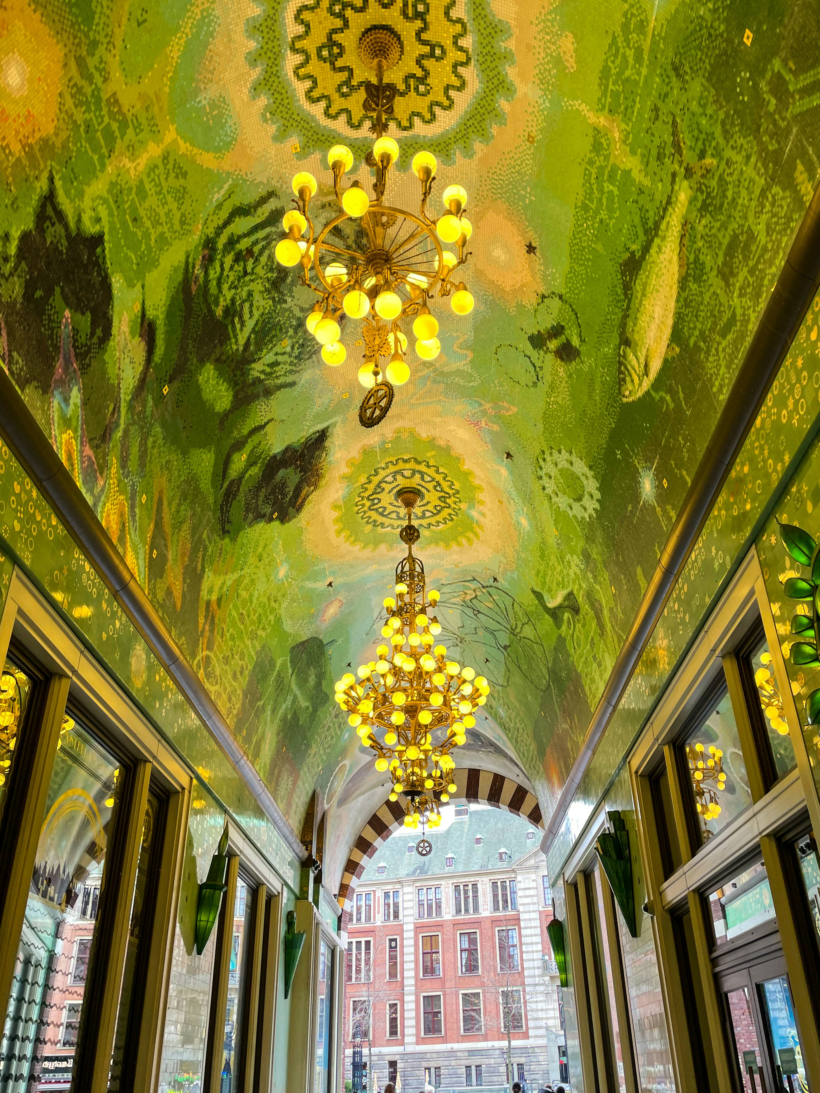 Verdant Vault: Chandelier Corridor Beneath a Painted Green Ceiling