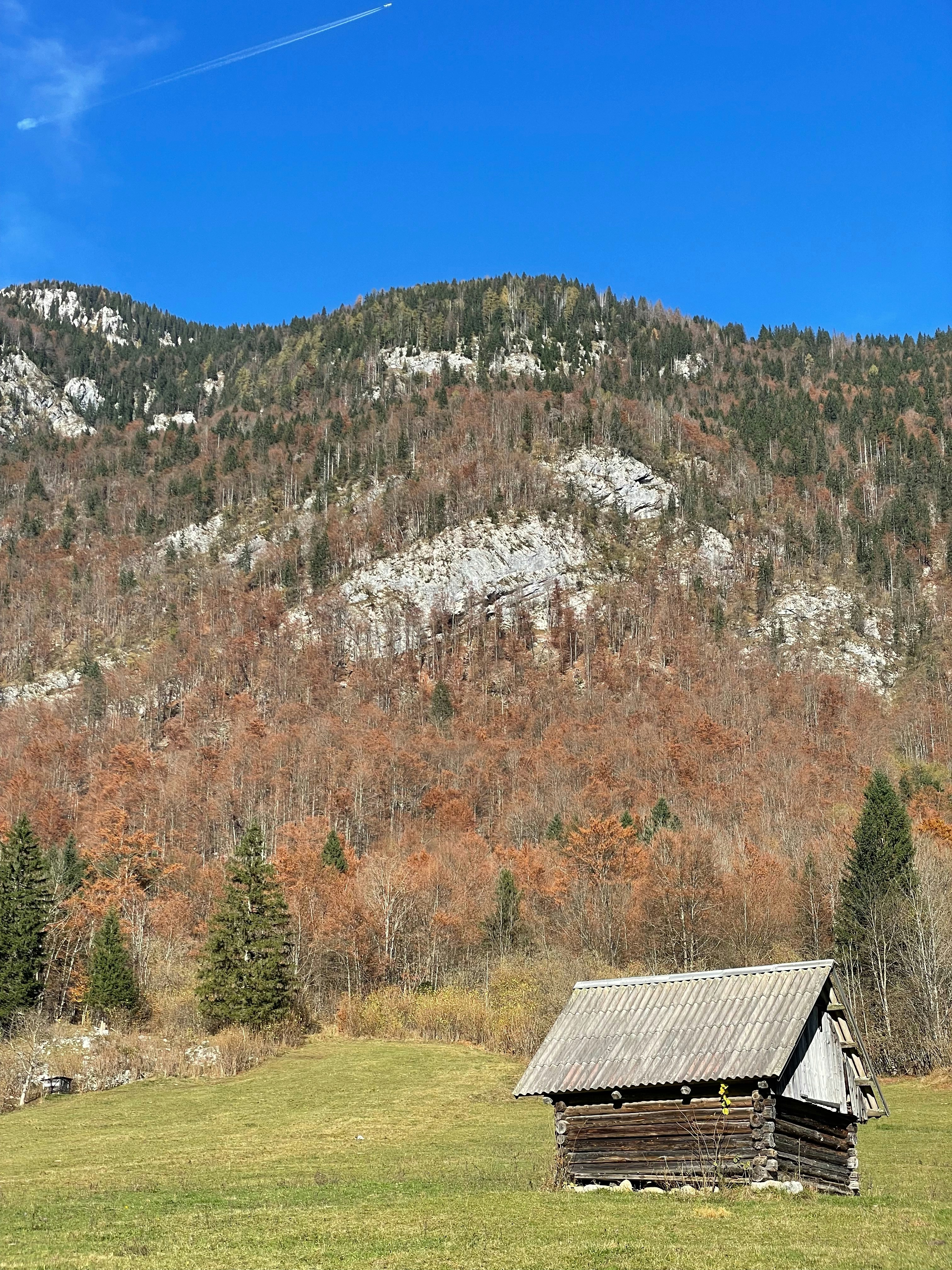 Autumn Cabin at the Foot of a Rugged Alpine Ridge