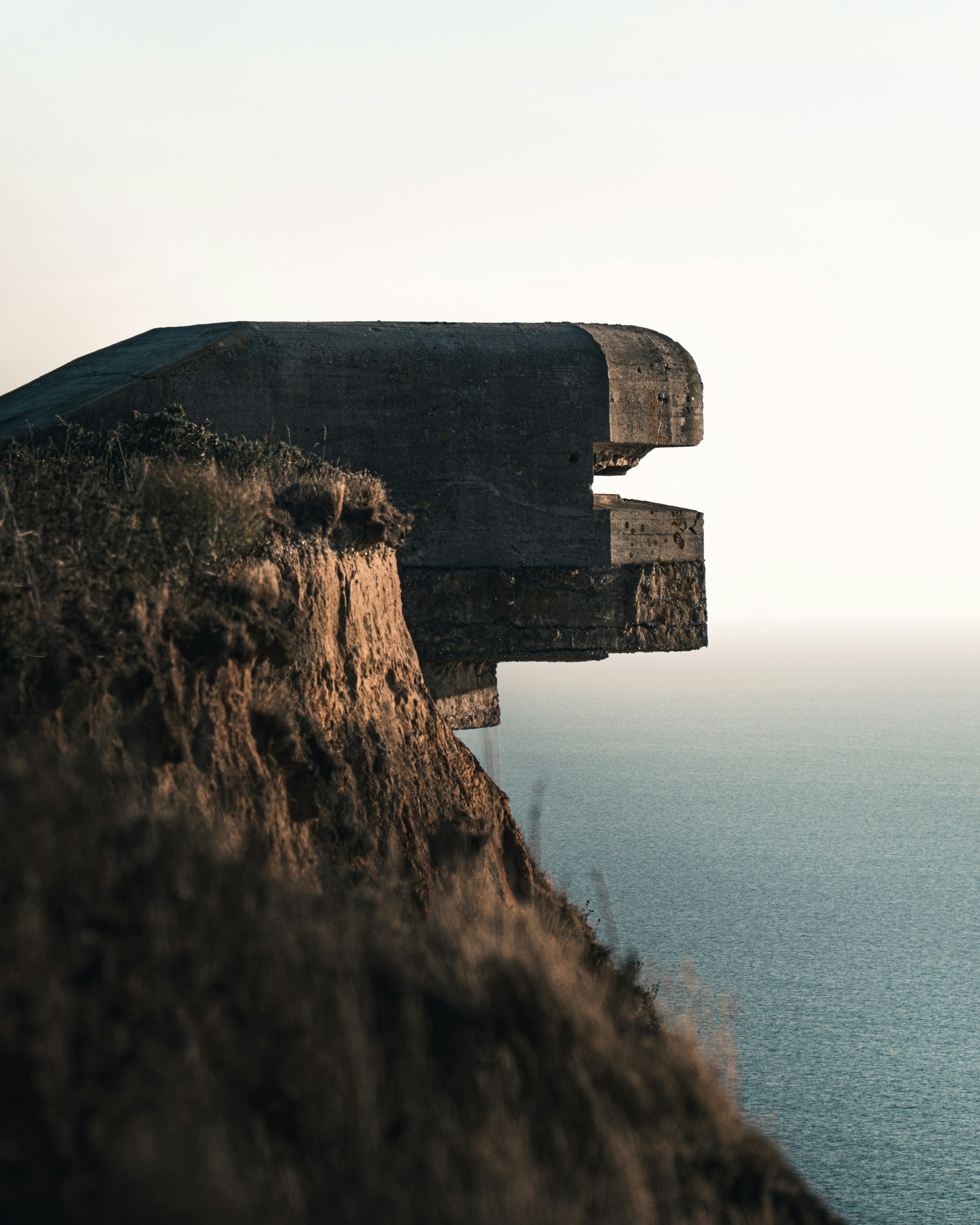 Edge of Silence: A Cliffside Concrete Embrace Over the Sea