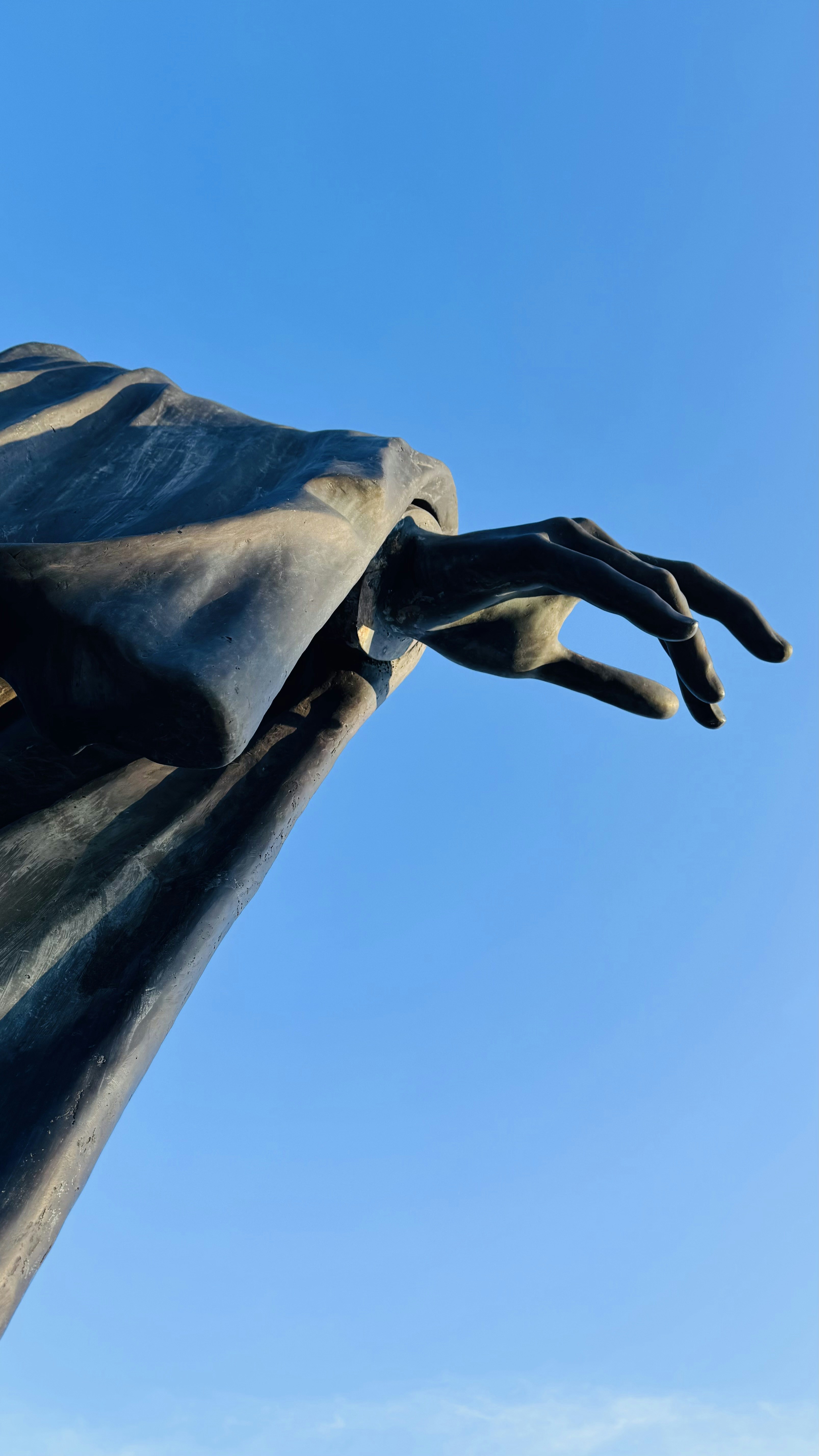 A statue’s reaching hand against a blue sky. photo – Free Art Image on ...
