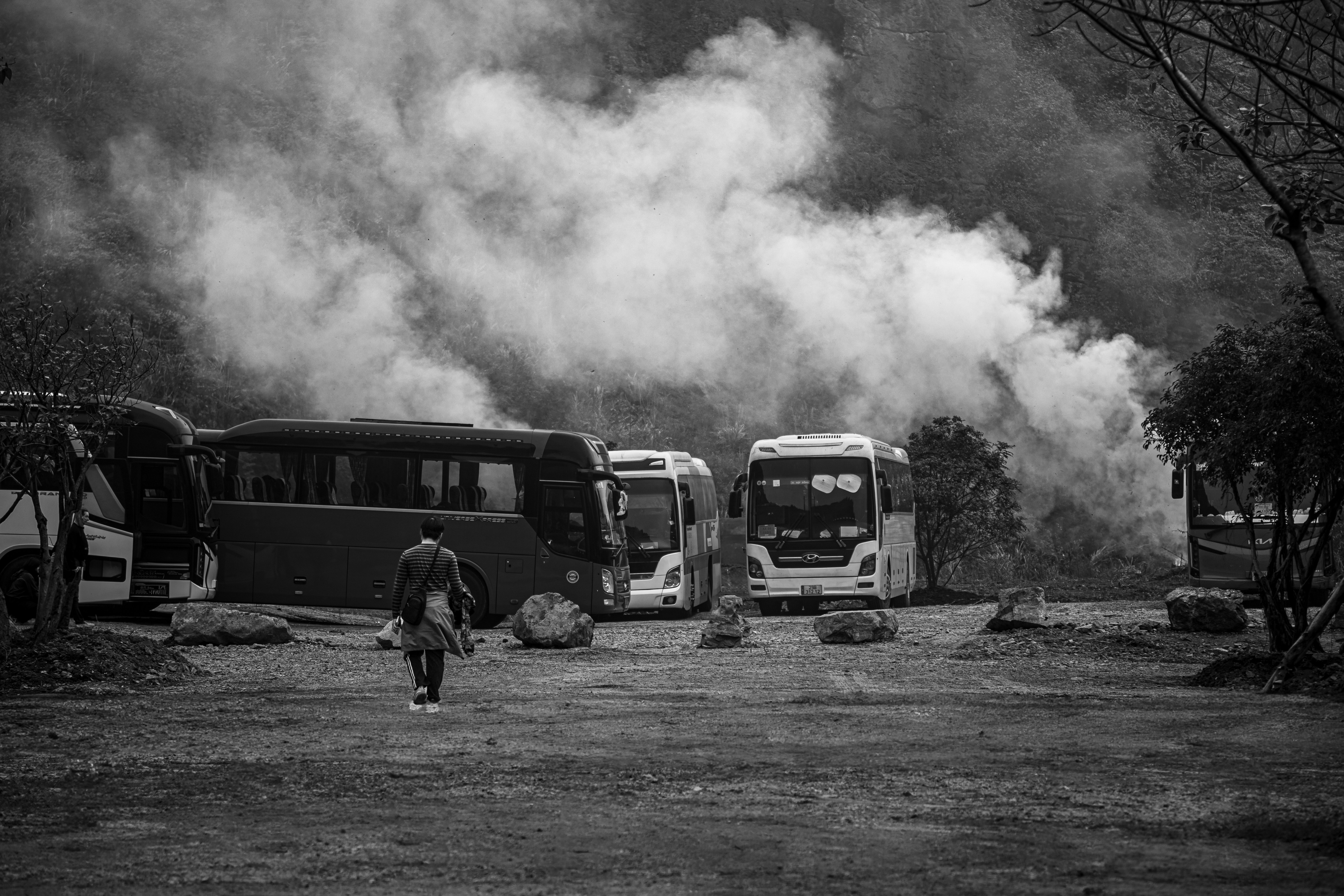 Buses are parked in front of smoky background. photo – Free Human Image ...