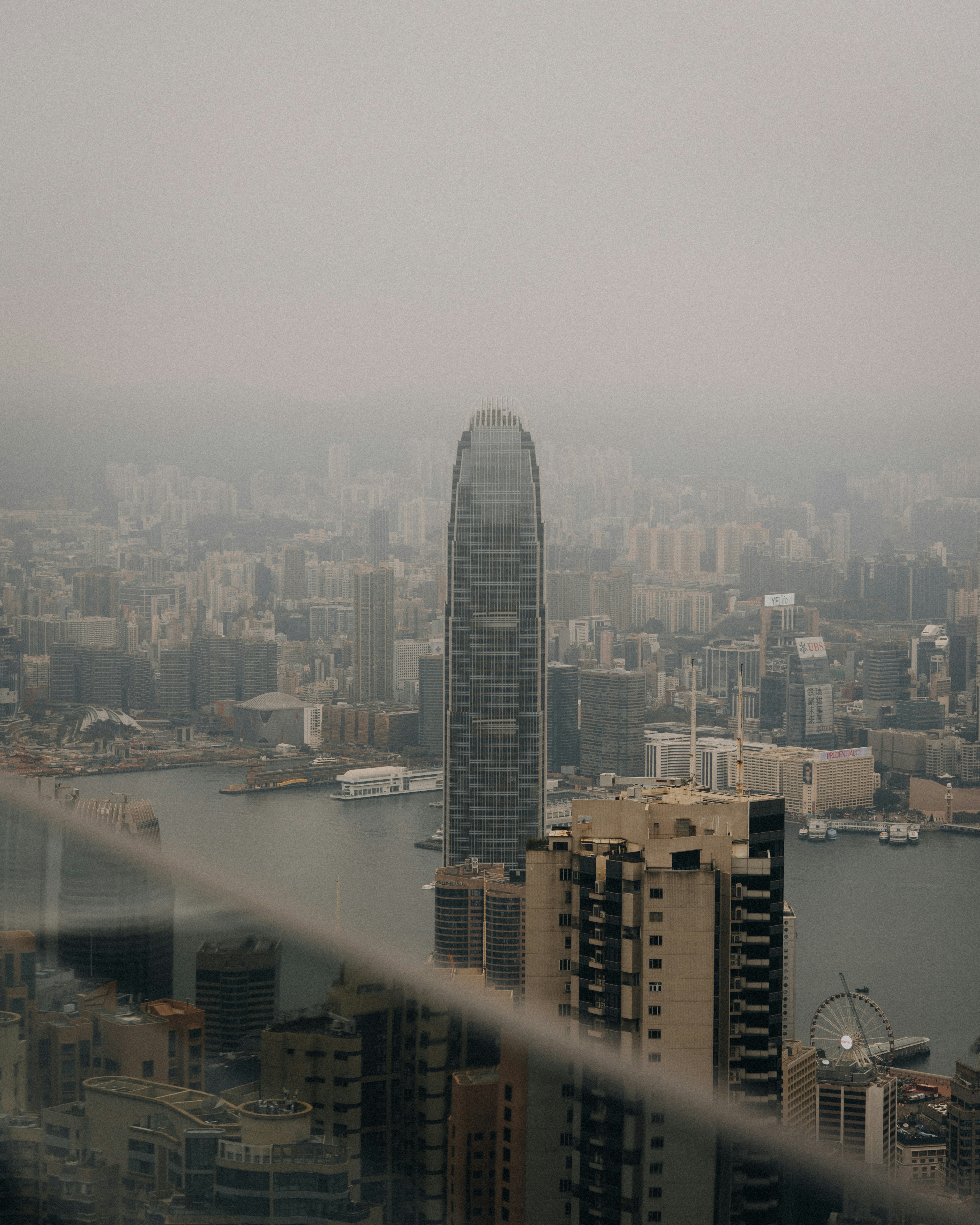 Mist-Crowned Spire Rising Over a Riverfront Skyline