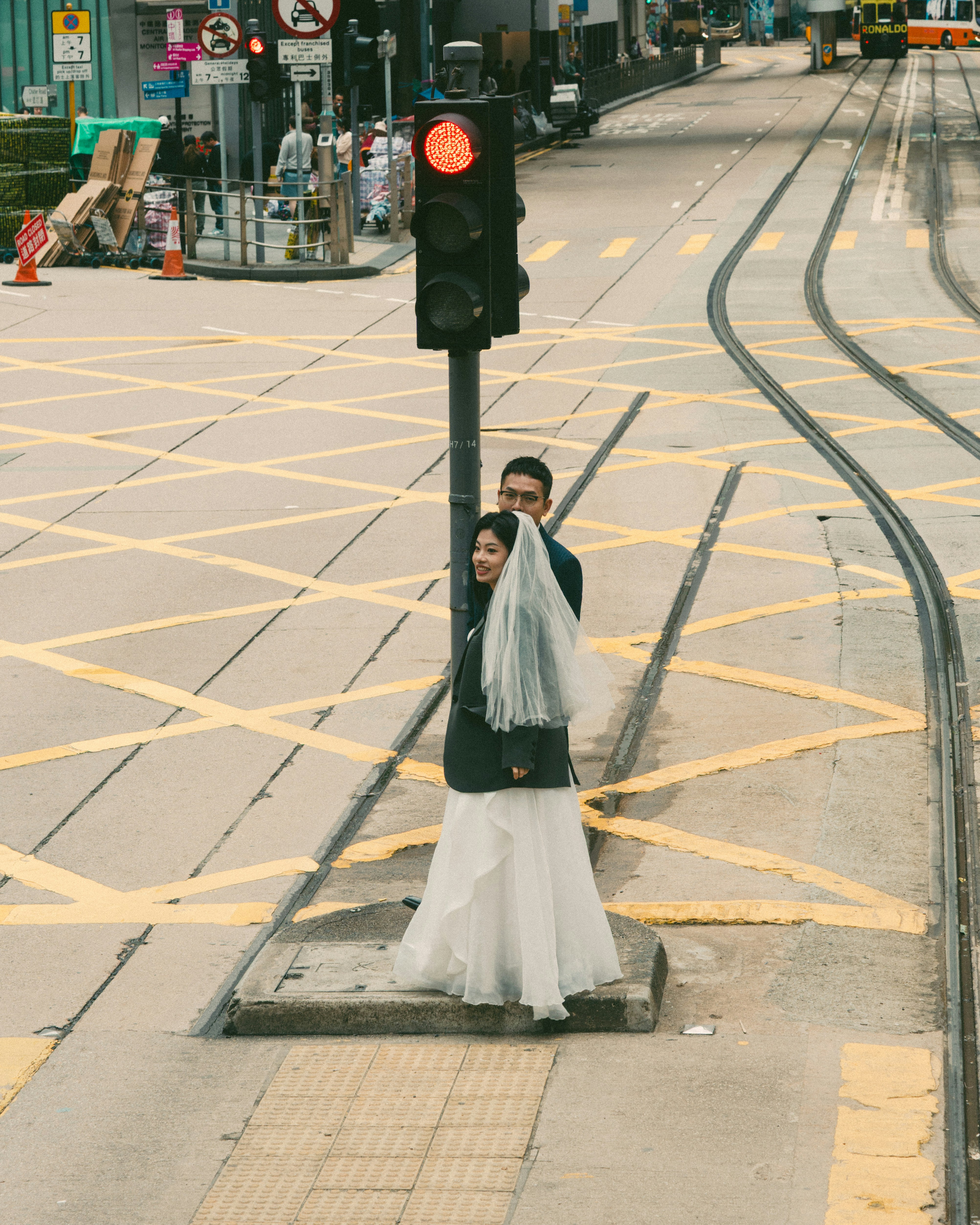 Urban Bride at the Crossing: Veil, Rails, and a Quiet Moment