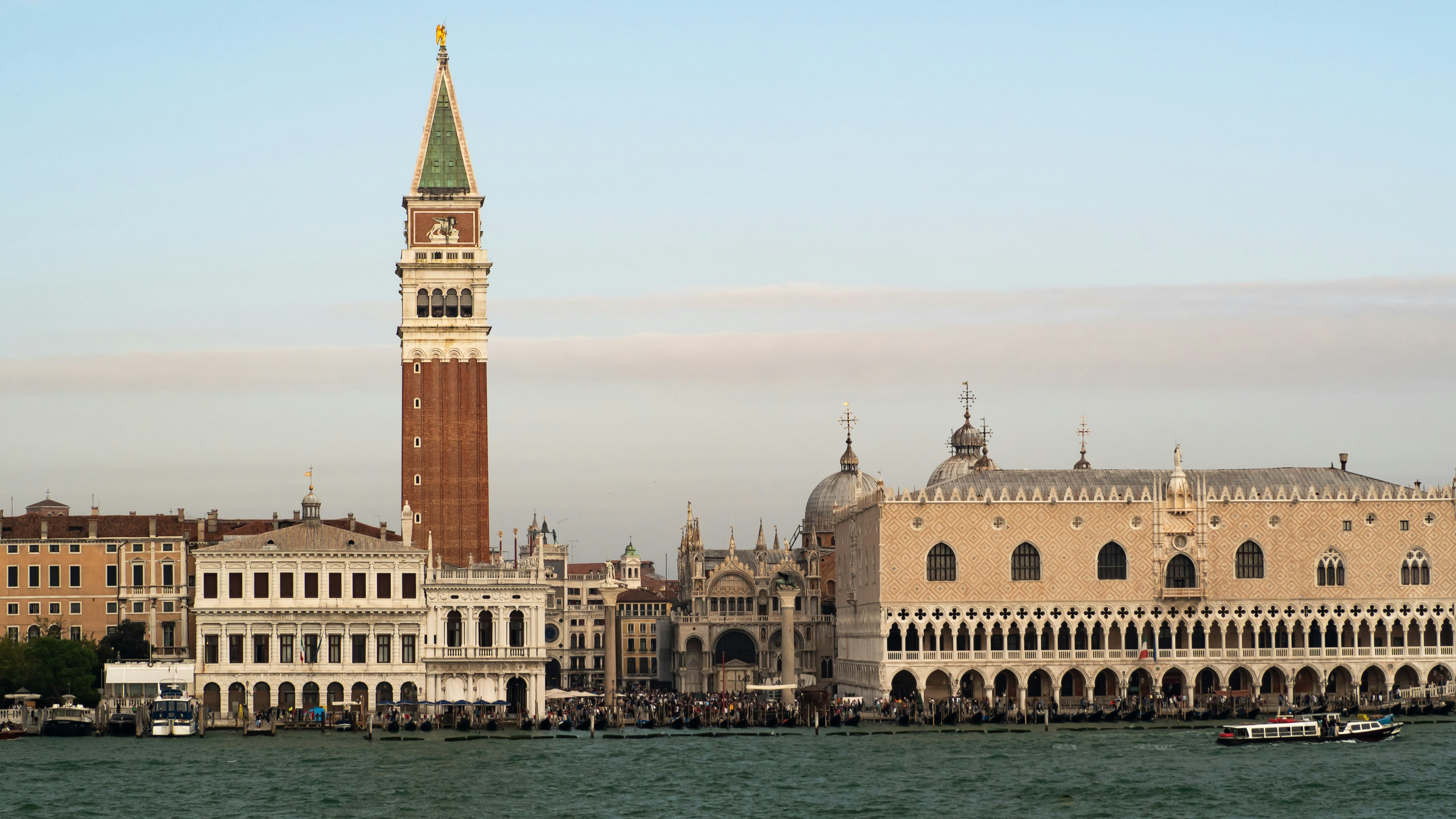 Venetian skyline featuring St. Mark's Campanile and the Doge's Palace at sunset.