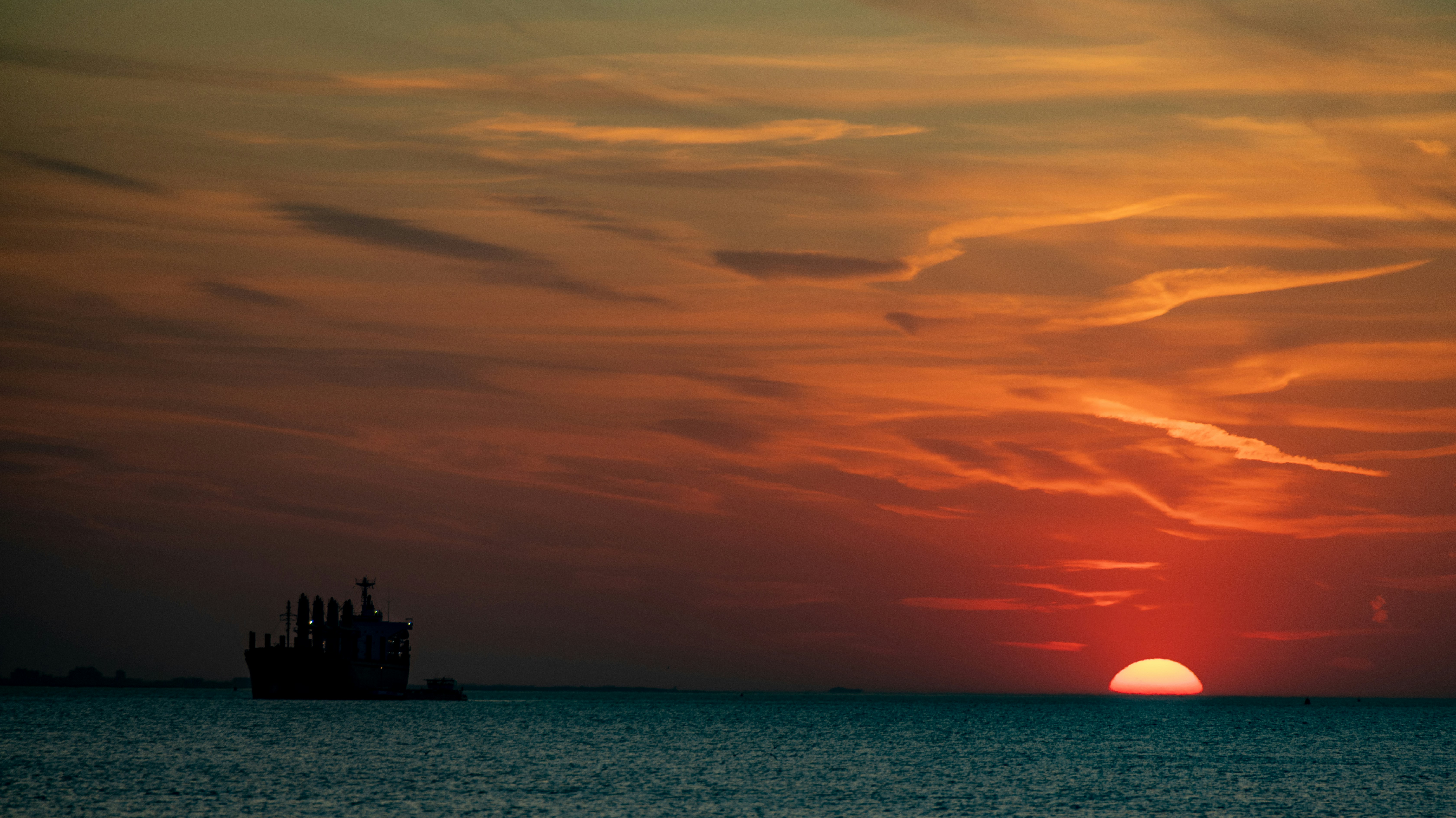 Sunset Voyage on a Tranquil Horizon