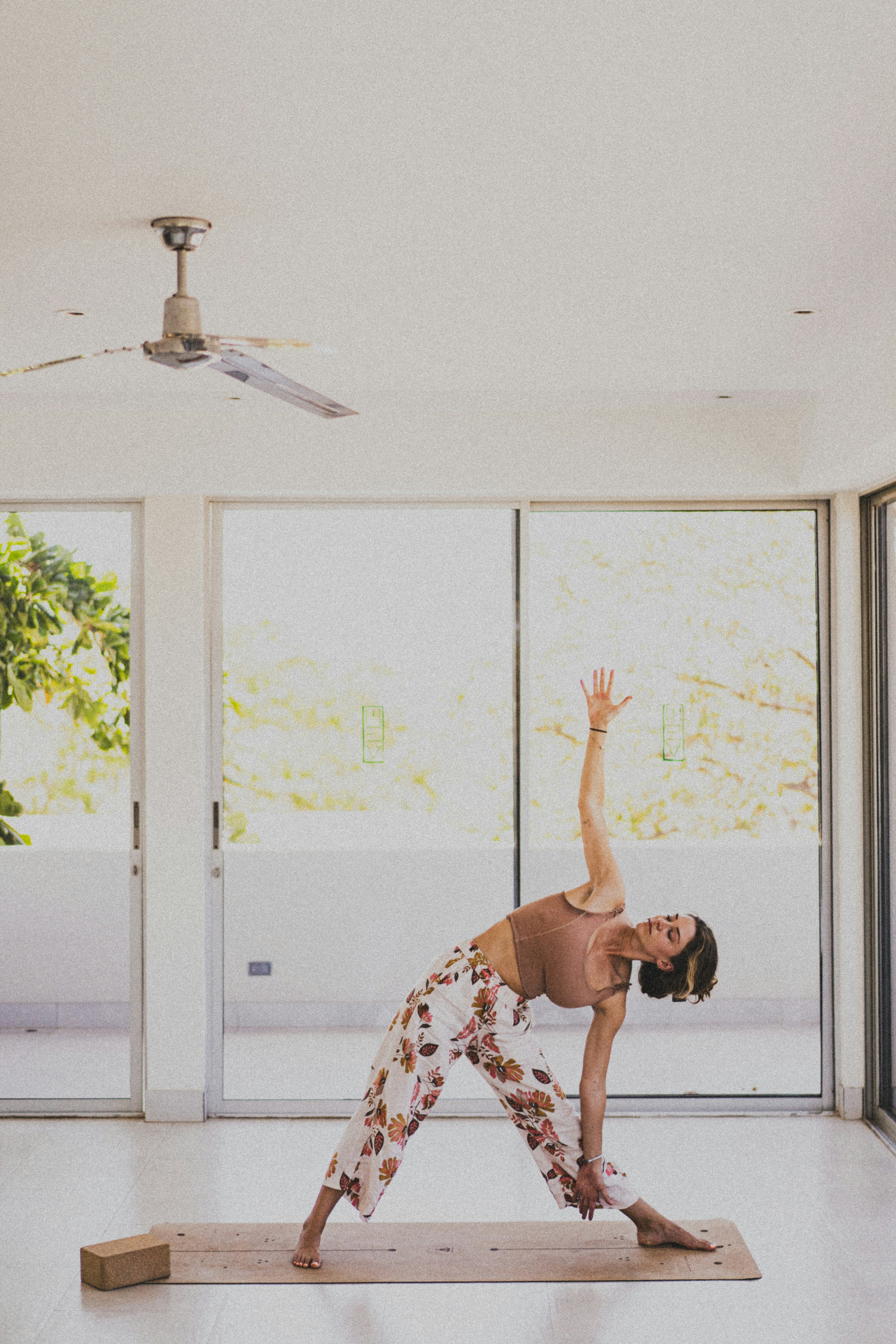 Woman practices yoga in a bright, open room. photo – Free Yoga Image on ...