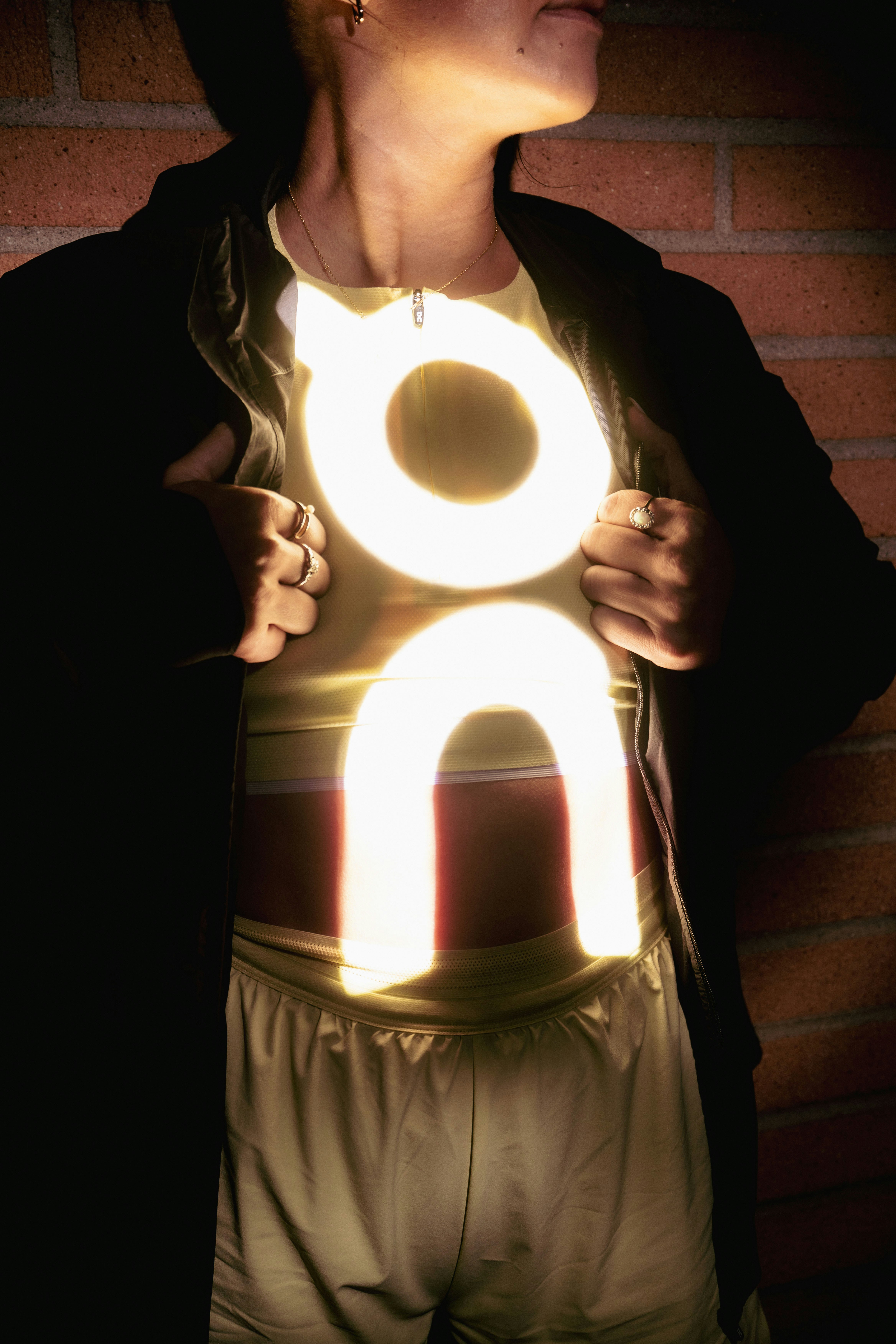 Glowing Glyph on Fabric: Neon Eight Illuminates a Quiet Portrait