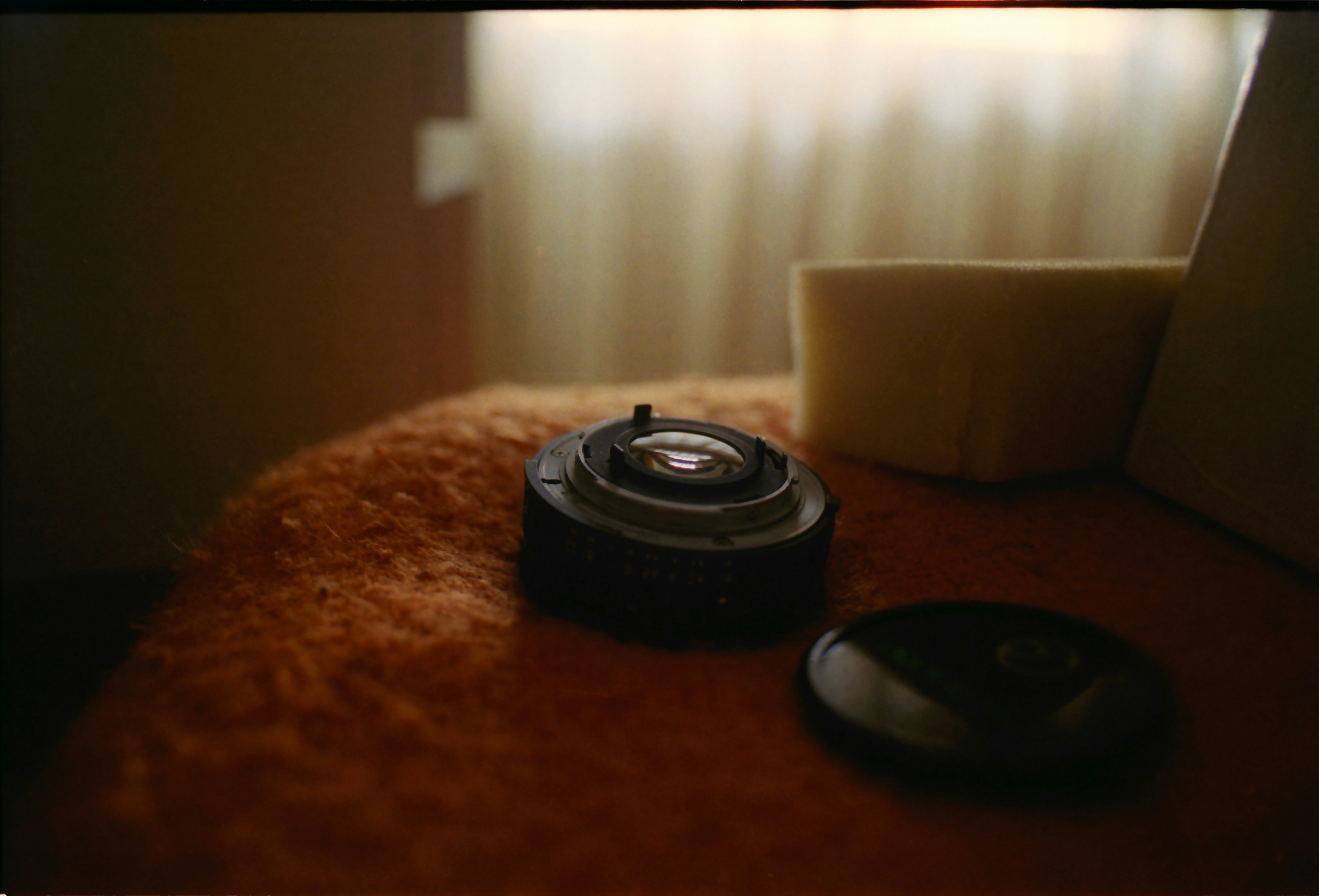 A camera lens lies on a fuzzy orange surface. photo – Free Photo Image ...