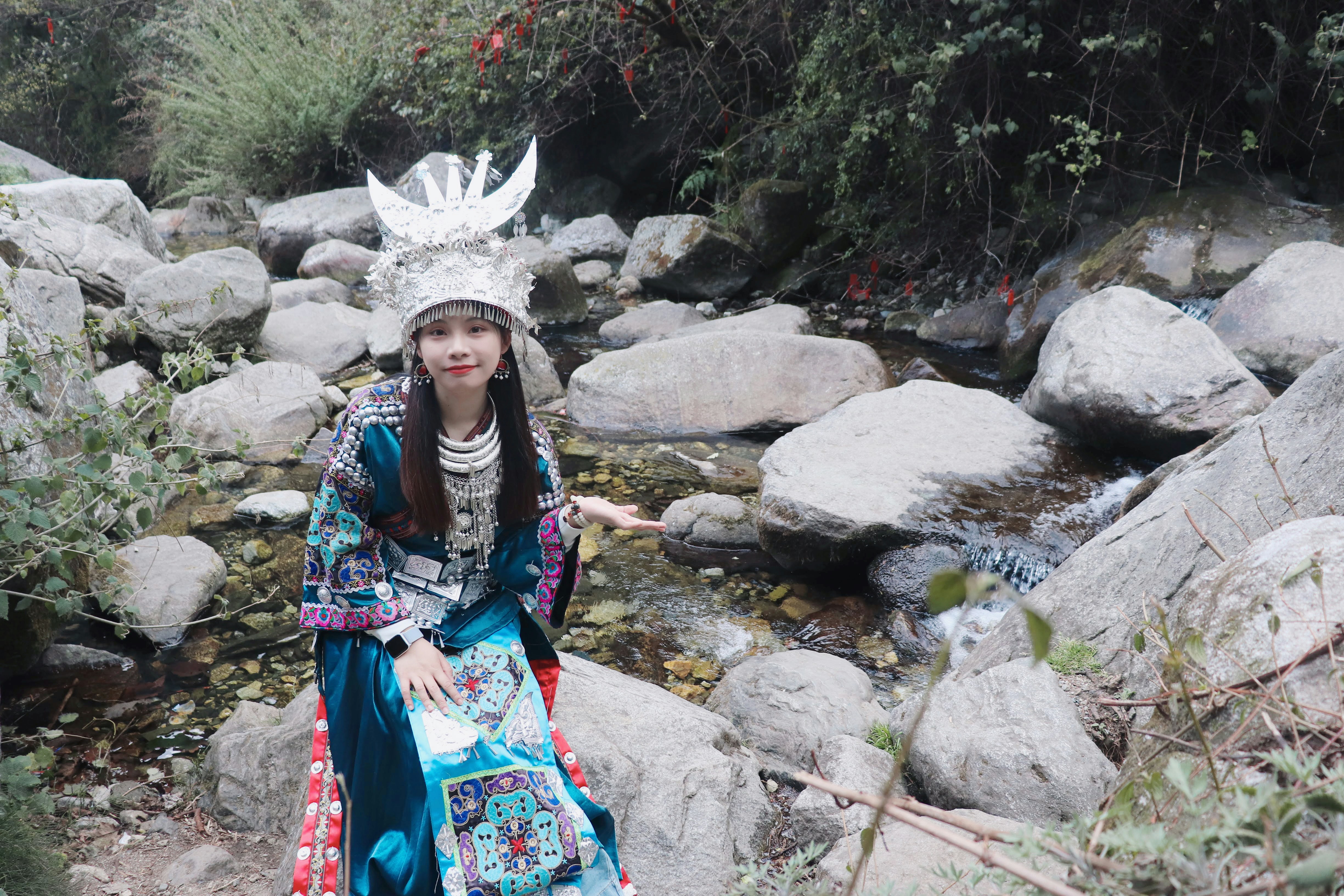 Woman in traditional dress poses by a stream. photo – Free Woman Image ...