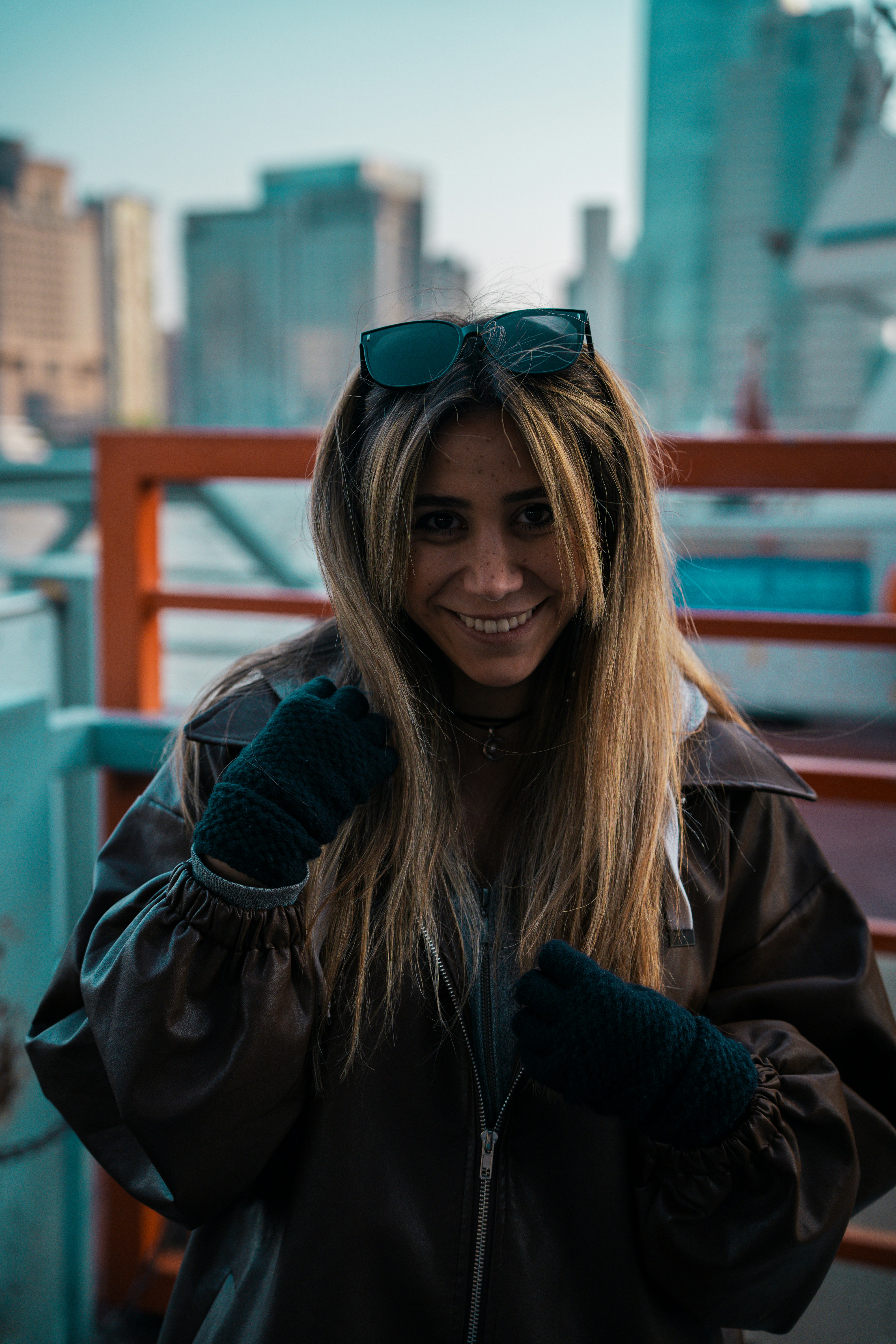 Smiling woman poses in front of city buildings. photo – Free Portrait ...