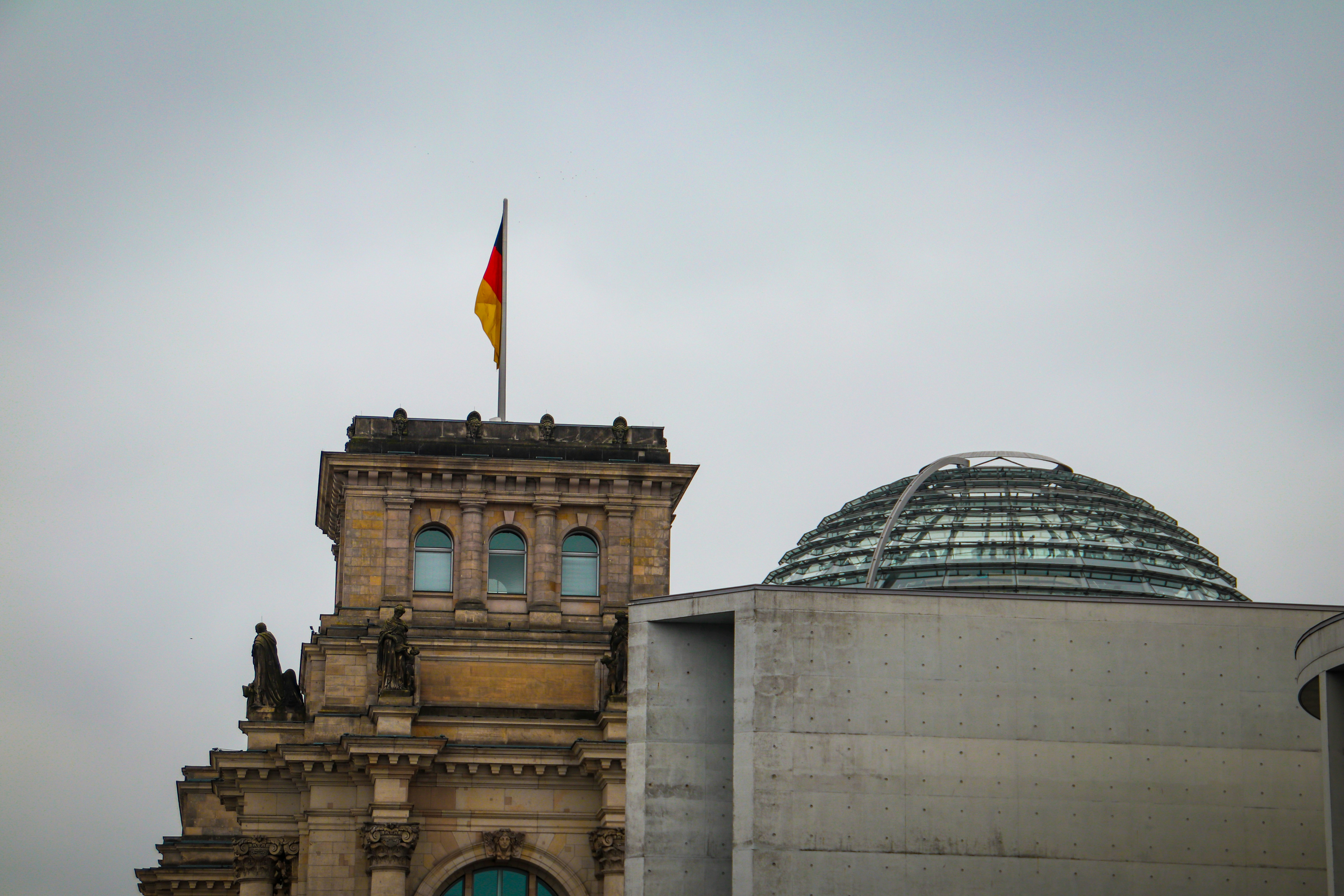 The reichstag building flies the german flag. photo – Free Building ...