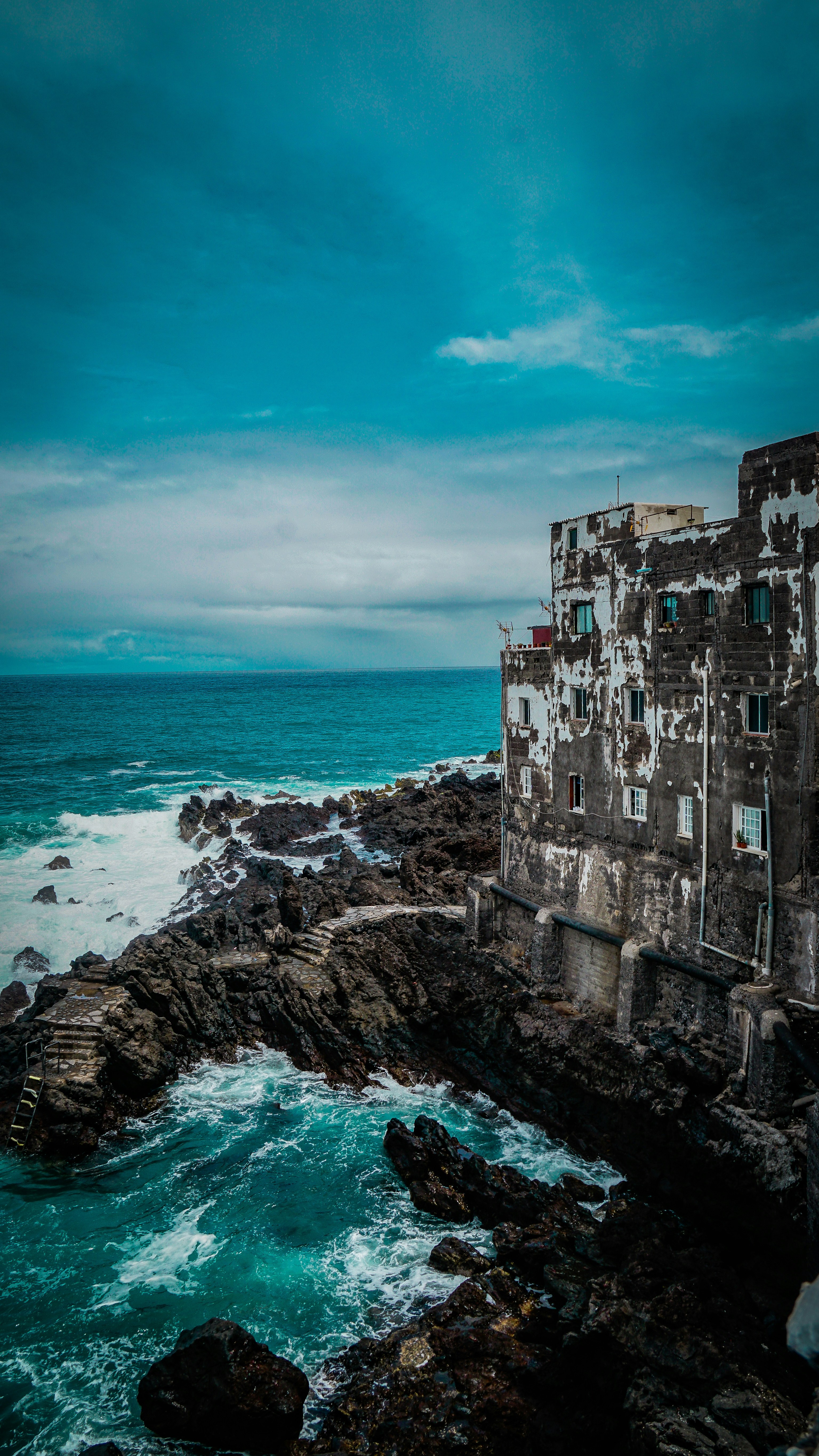 Cliffside Ruin Braving the Turquoise Surge