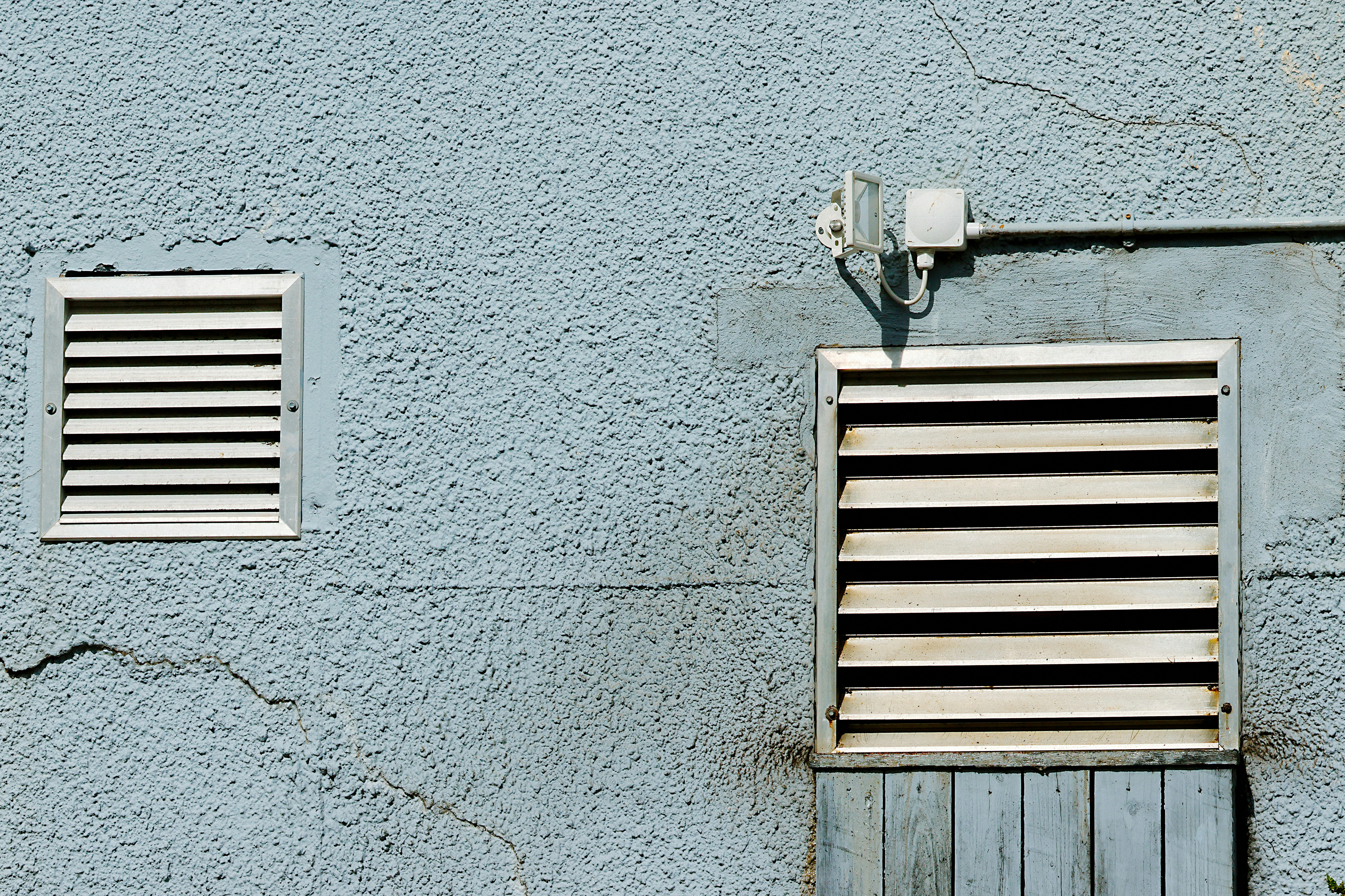 Two vents are set into a textured blue wall. photo – Free Wall Image on ...