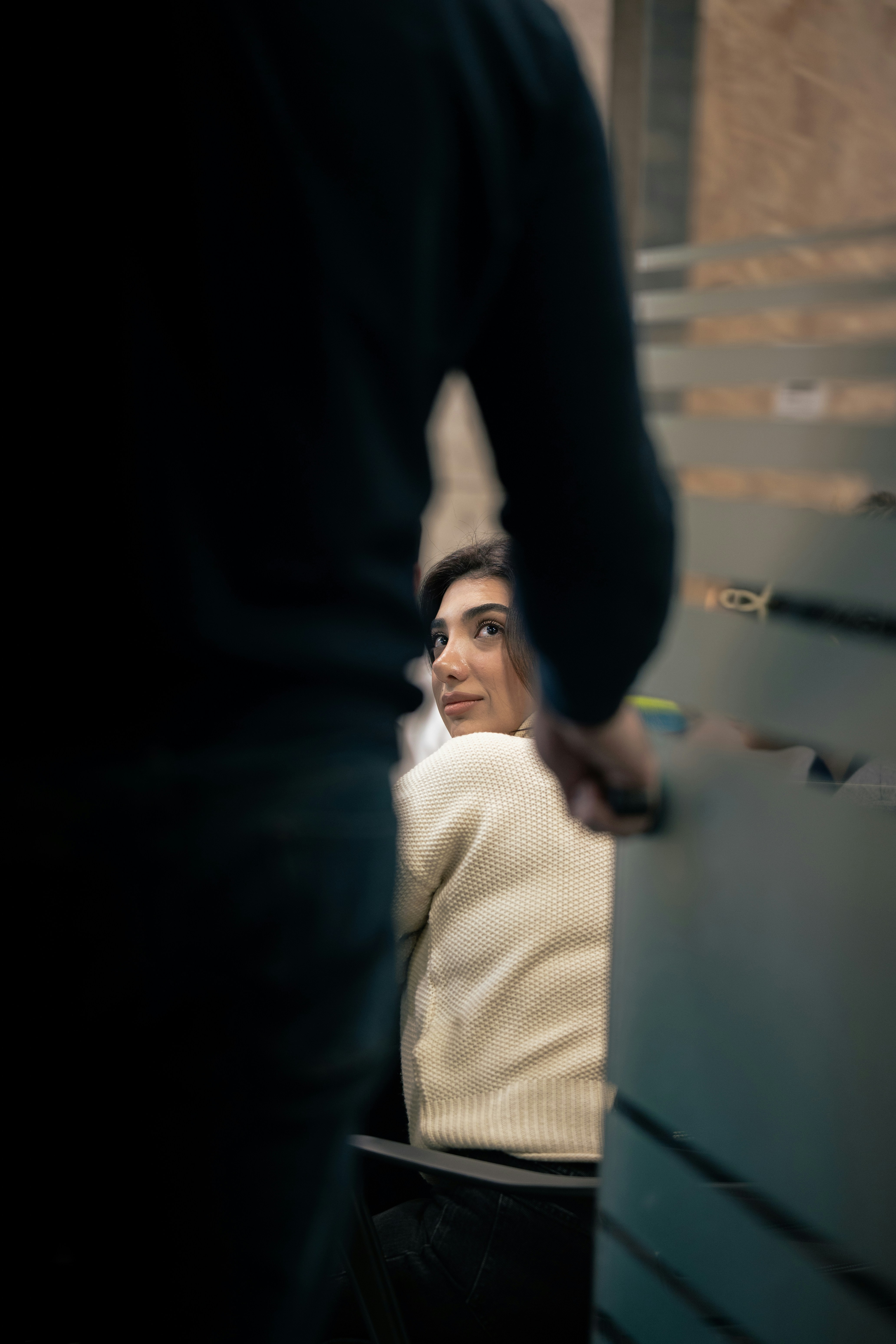 Eyes Through the Glass: A Quiet Gaze in a Dim Corridor