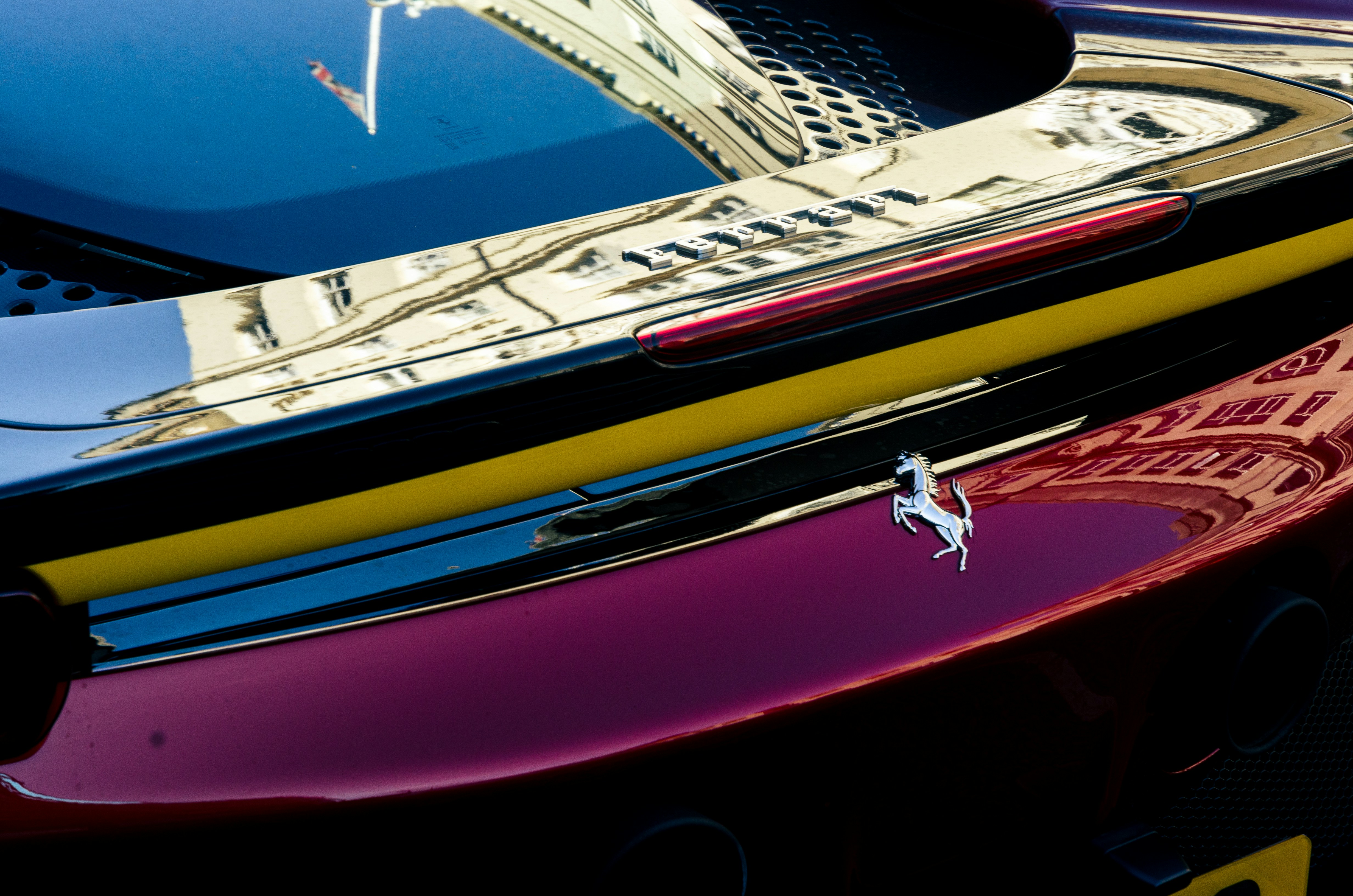 A shiny ferrari rear view is displayed. photo – Free Car Image on Unsplash