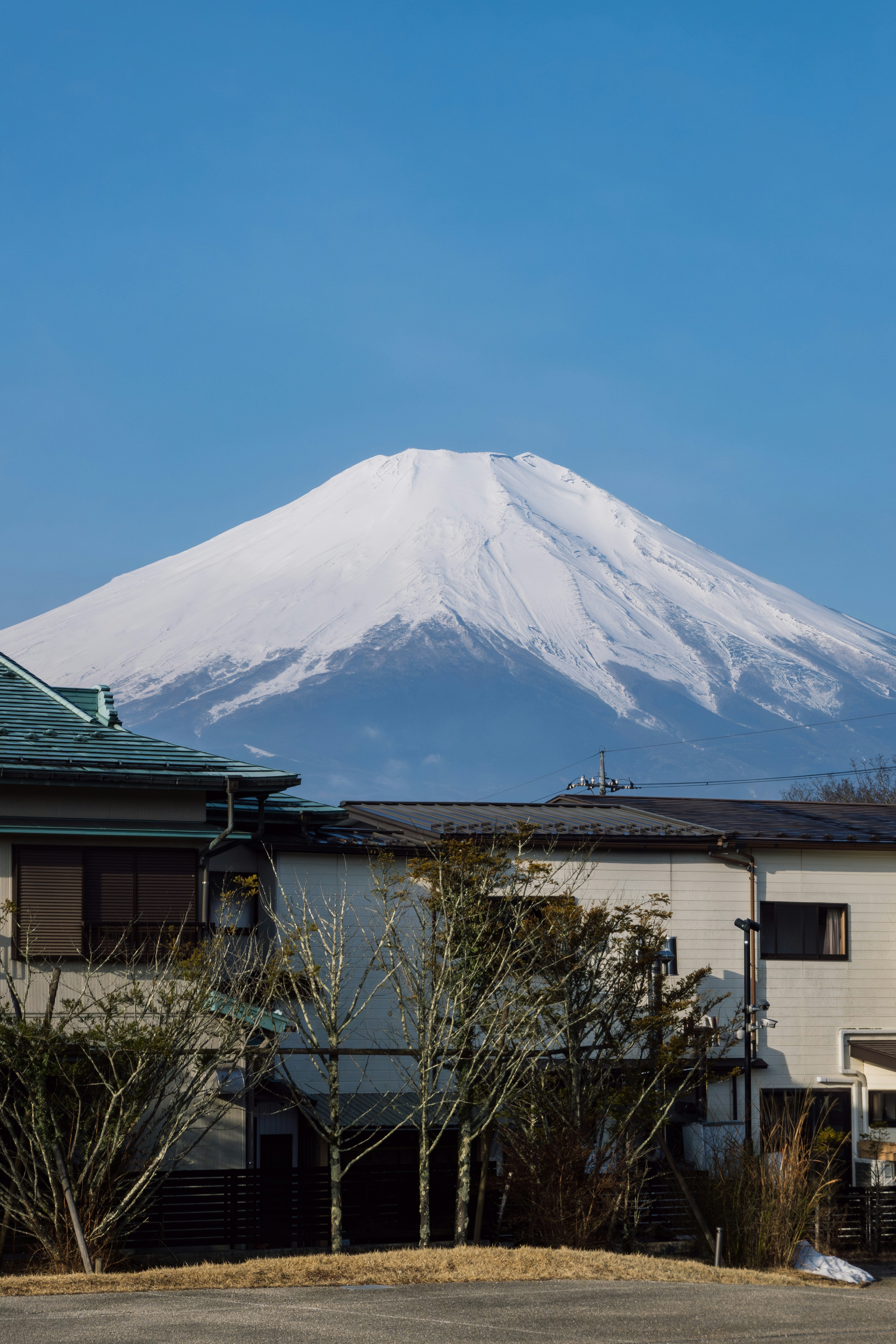 Fuji's Snow Crown Over a Quiet Suburban Horizon