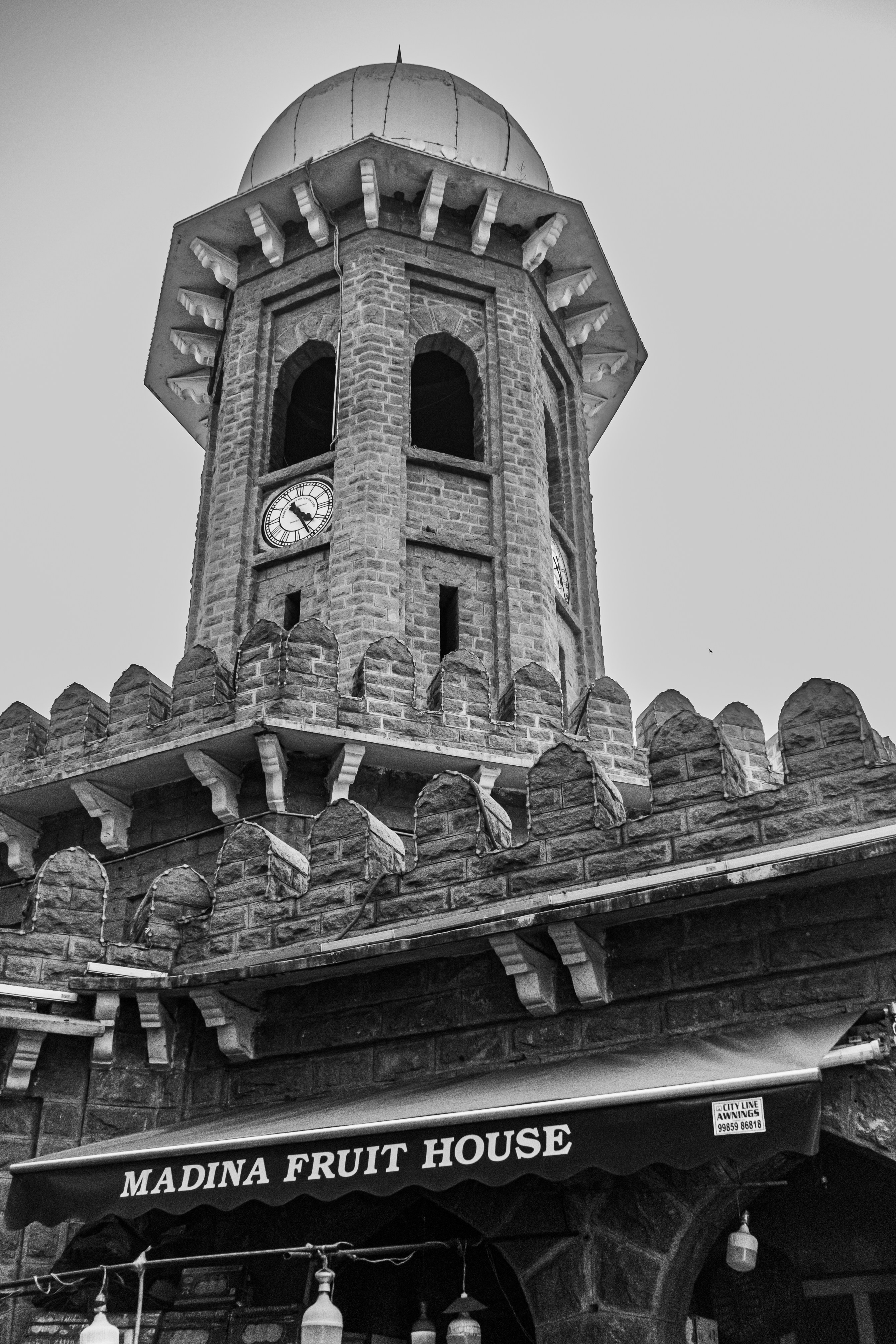 Clocktower Lantern Above the Market: Weathered Brick Turret with a Domed Cap