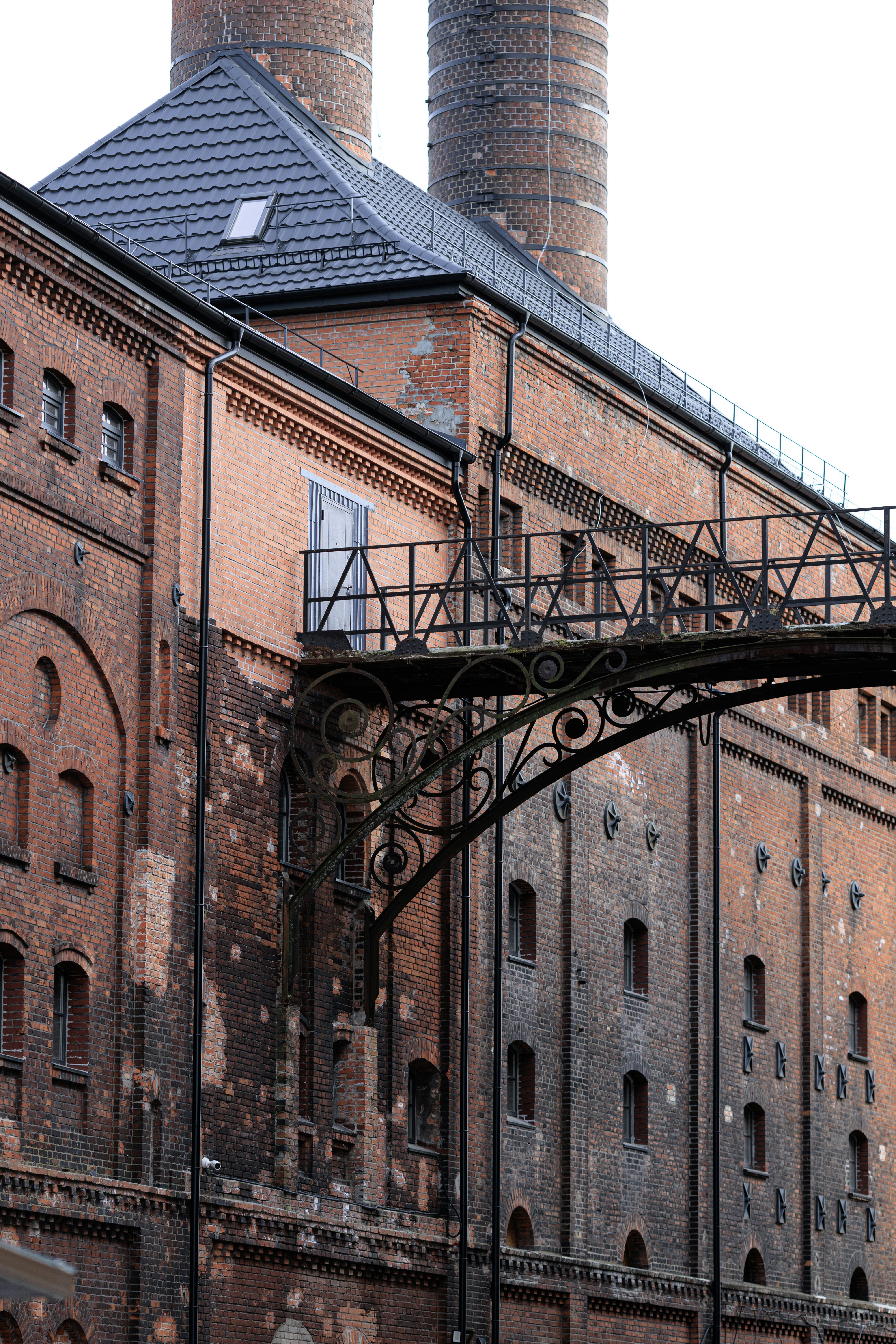 An old, weathered brick building with chimneys.