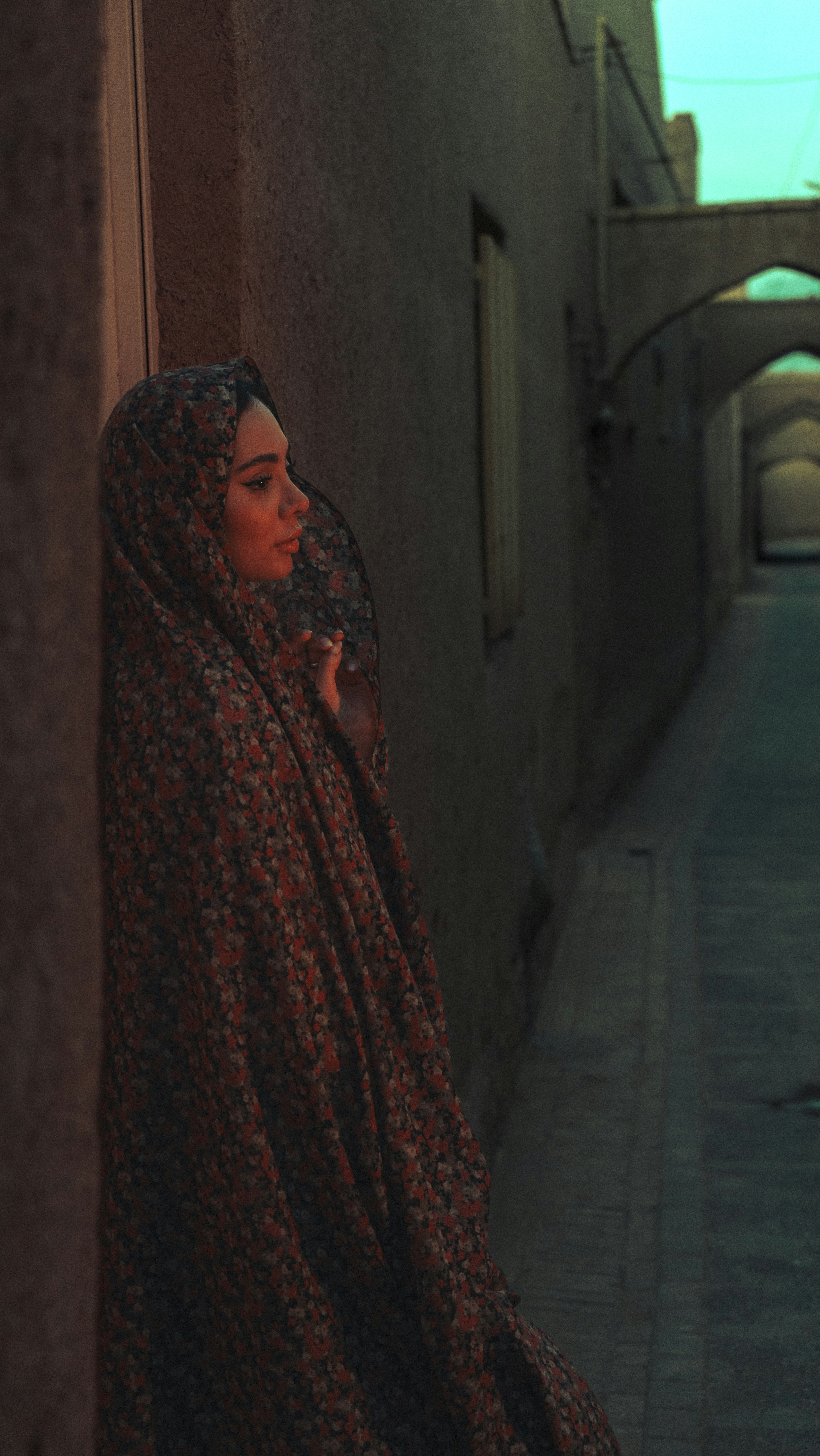 A woman in a hijab stands in a dim alley. photo – Free Islamic Image on ...