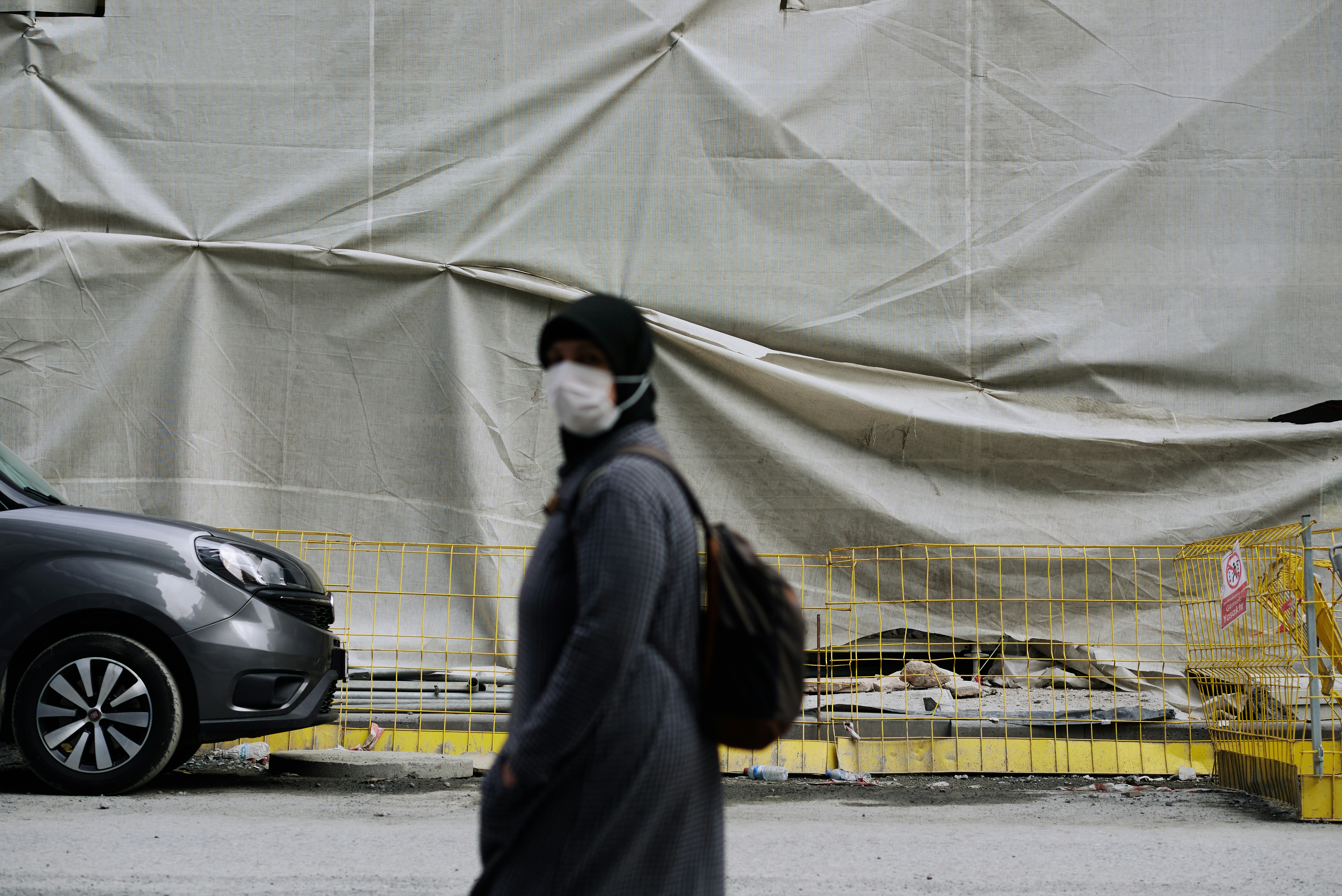 Kristina Tochilko – fashion and documentary photographer capturing cinematic moments with a refined aesthetic. Explore my profile for architecture, fashion, and travel visuals. Download and use in your projects! #photostock #visuals | A person wearing a mask walks by a car.