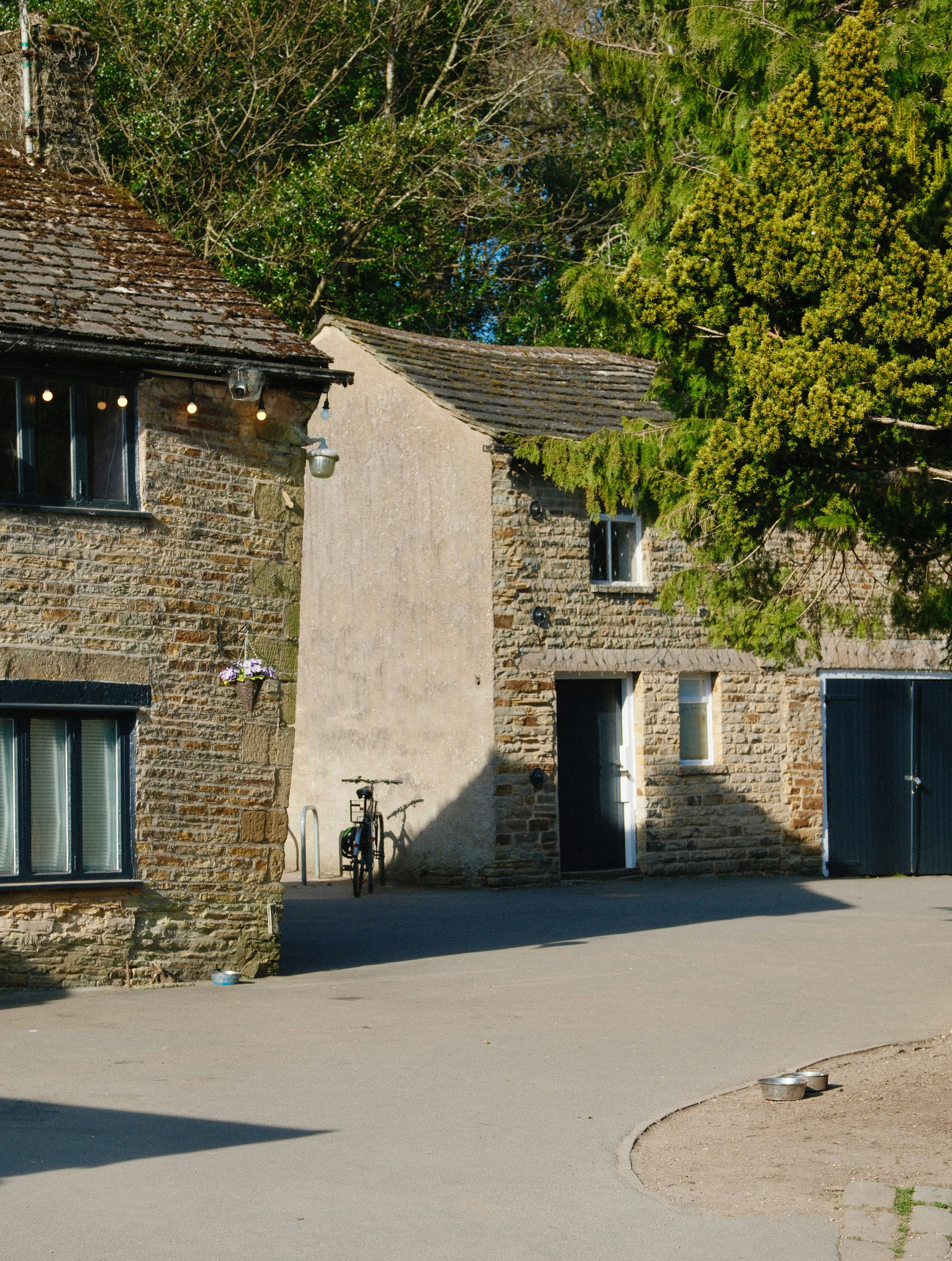 Stone buildings and a bicycle are visible.