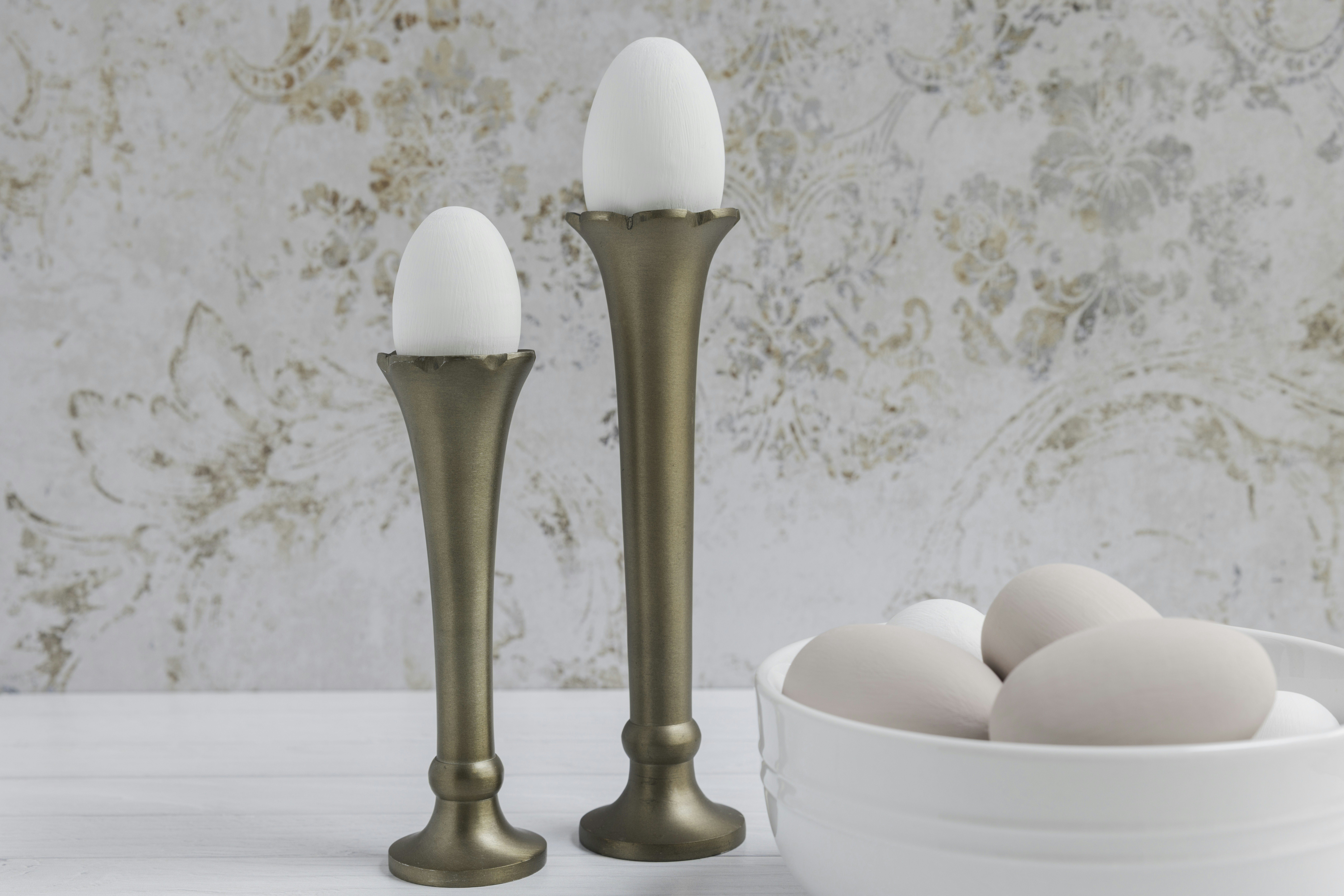 Brushed Bronze Candlesticks and a Bowl of Pale Eggs