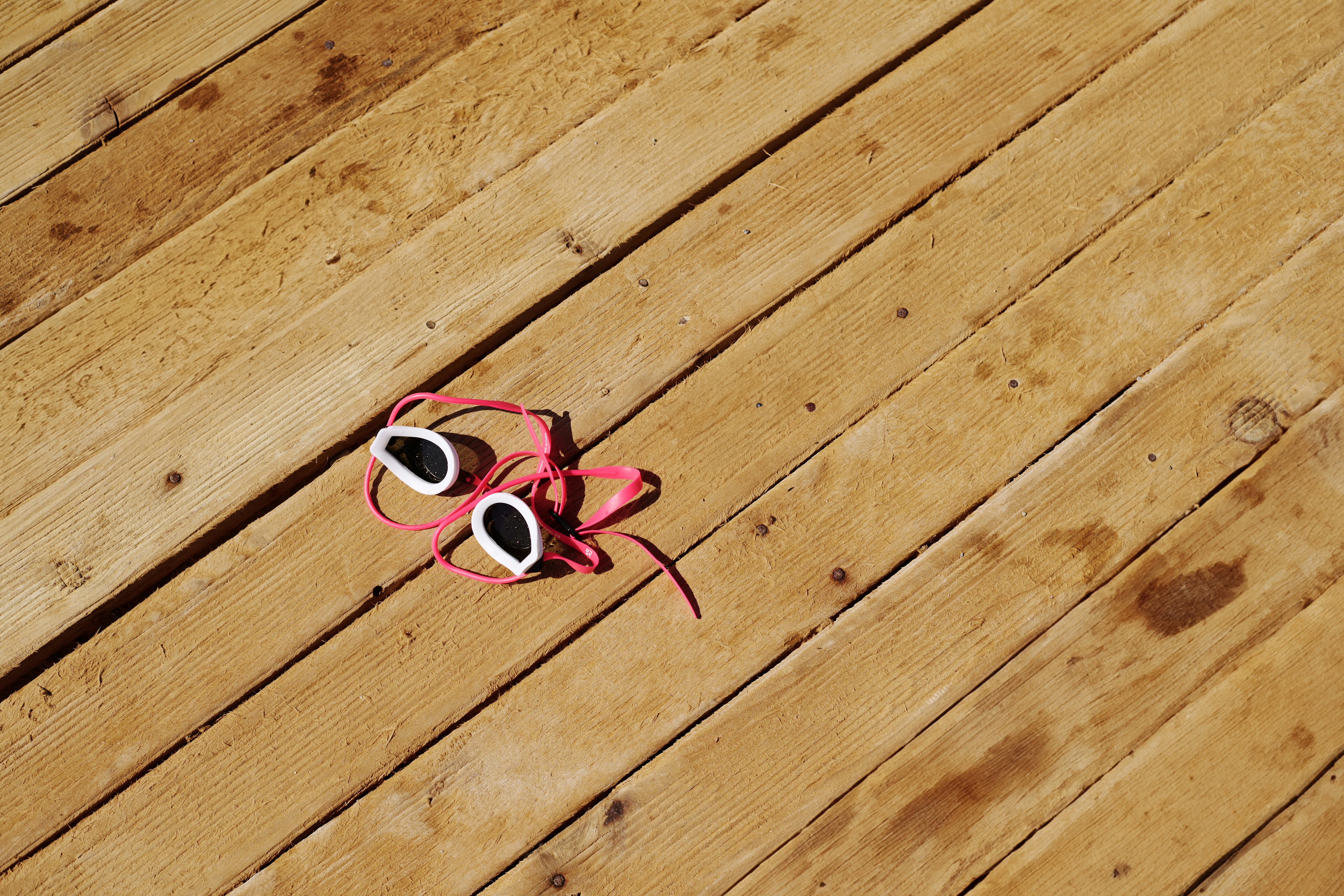 Rosy Sunglasses Rest on Weathered Planks