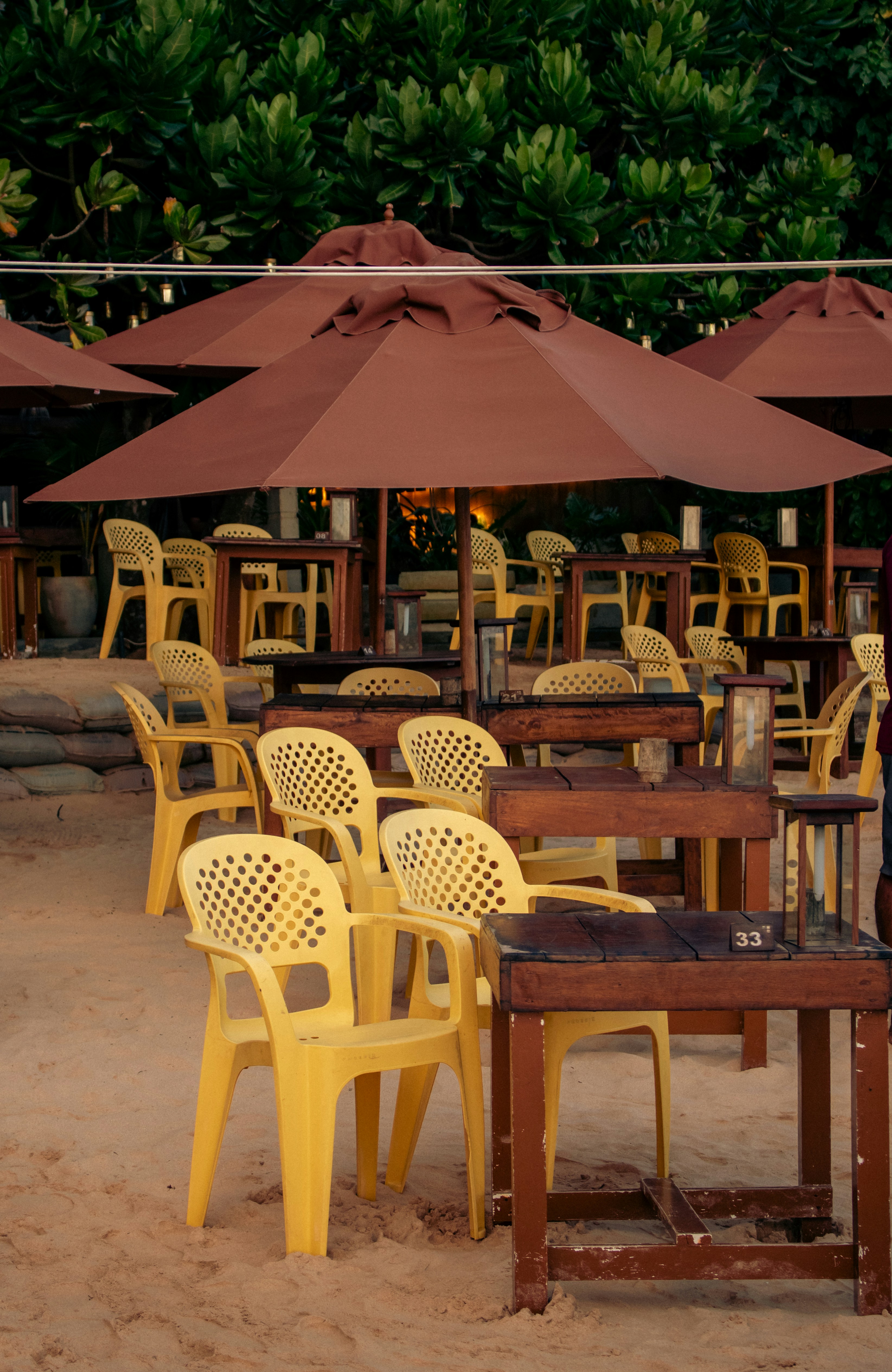 Tables and chairs set up at a beach restaurant. photo – Free Beach ...
