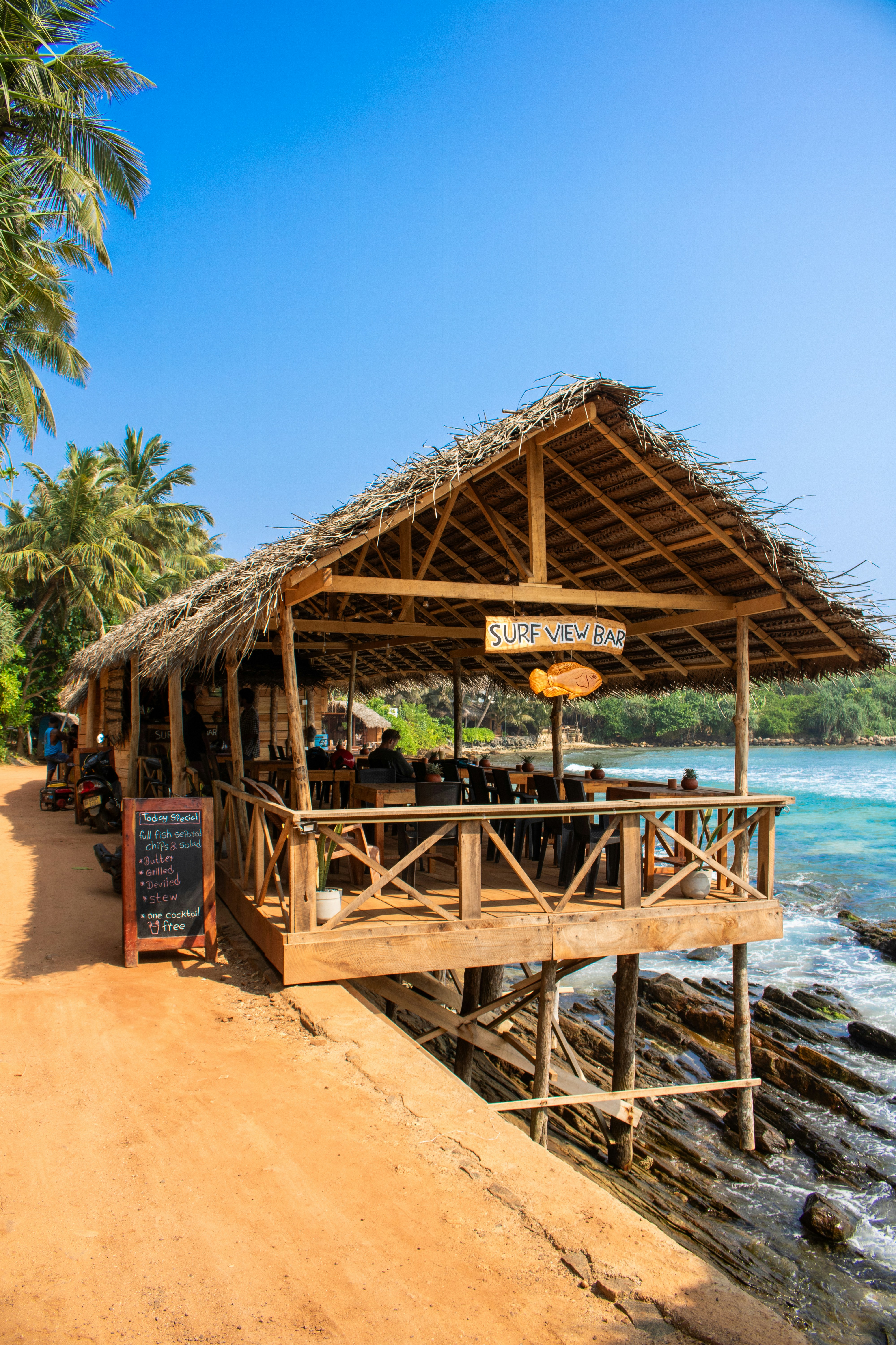 A rustic beach restaurant overlooks the beautiful sea. photo – Free ...