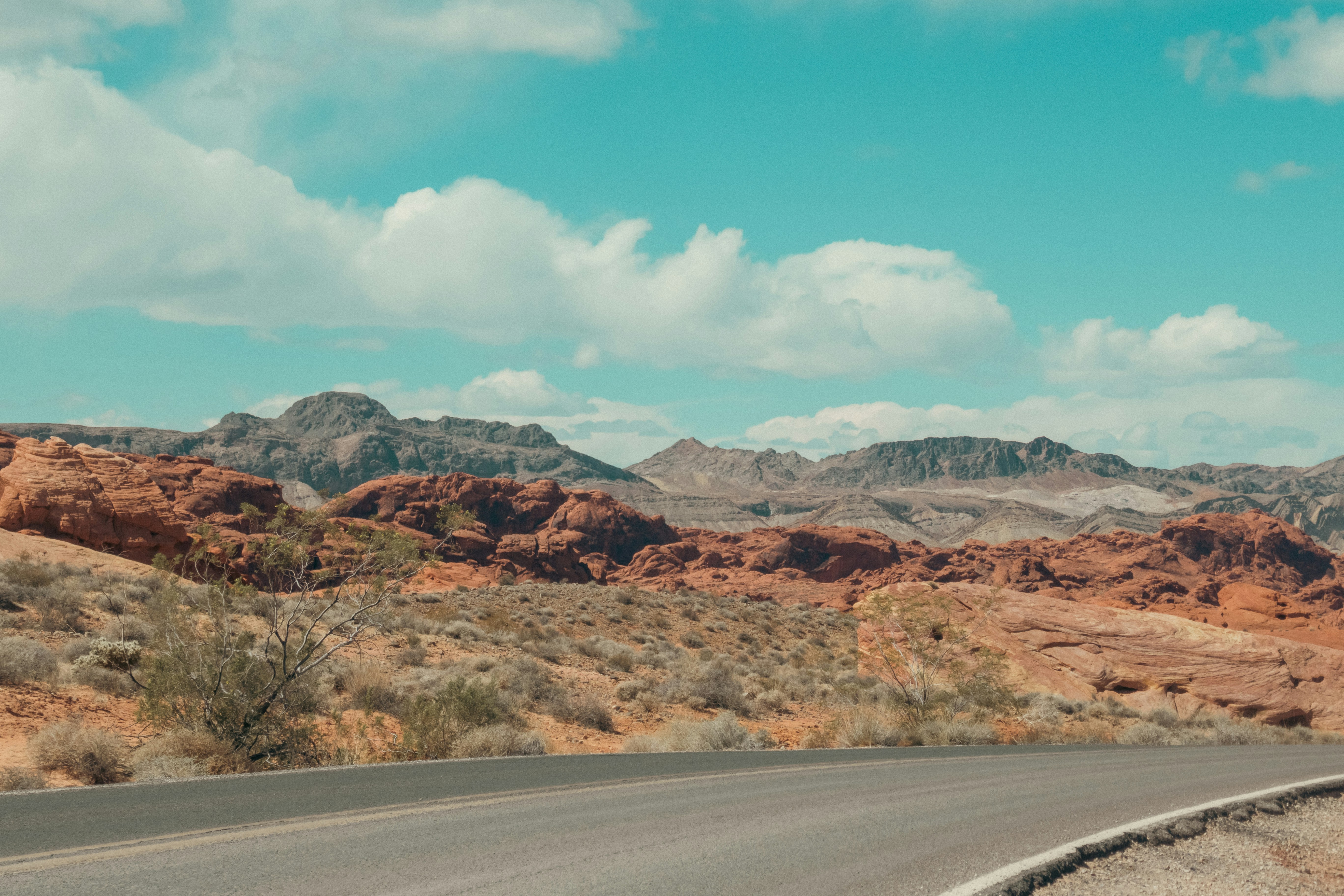 Road leads through a desert landscape under a blue sky. photo – Free ...