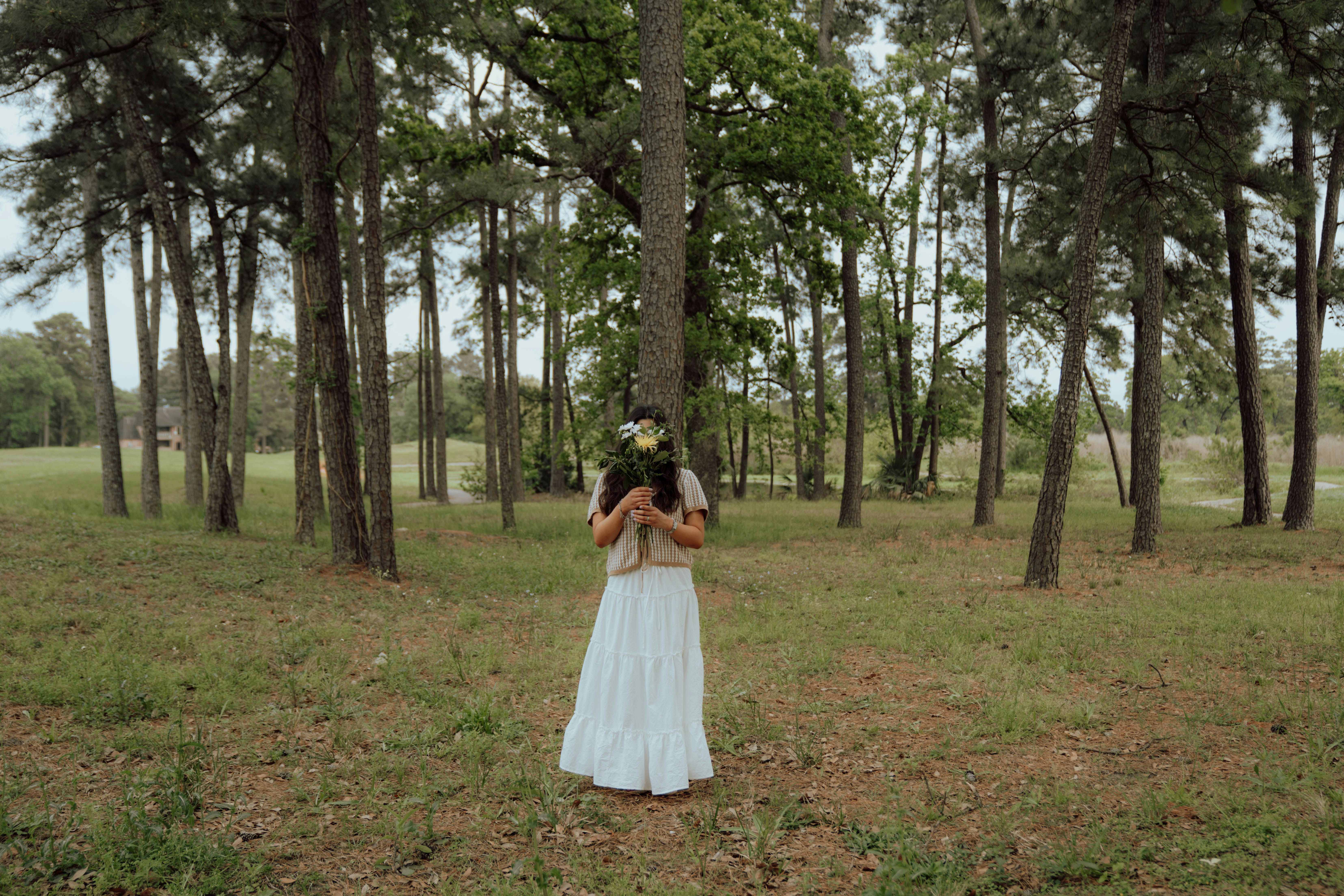 Bride in a White Dress Stands Among Whispering Pines