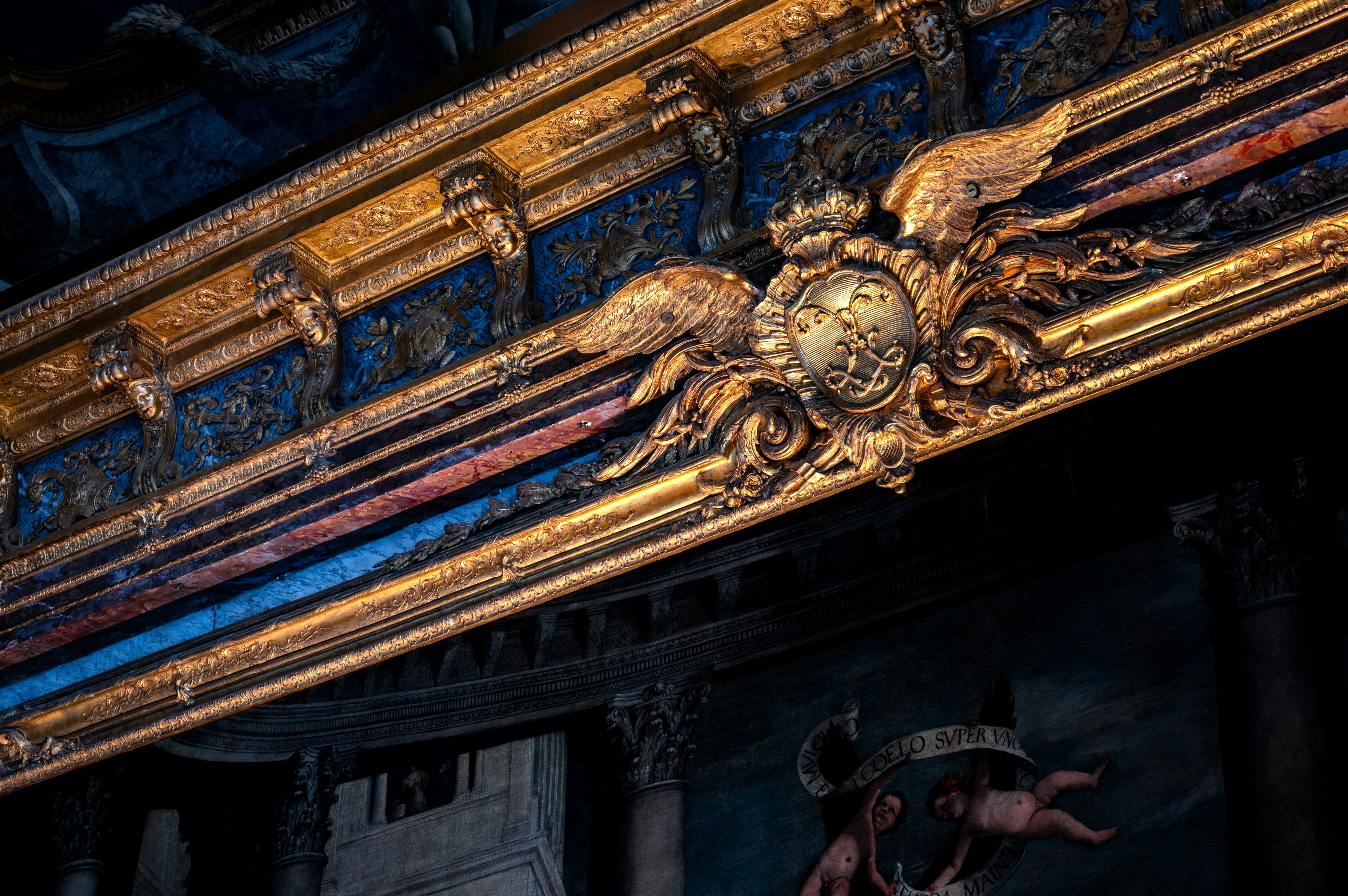 Intricately detailed gilded architectural ornamentation with rich textures and colors.