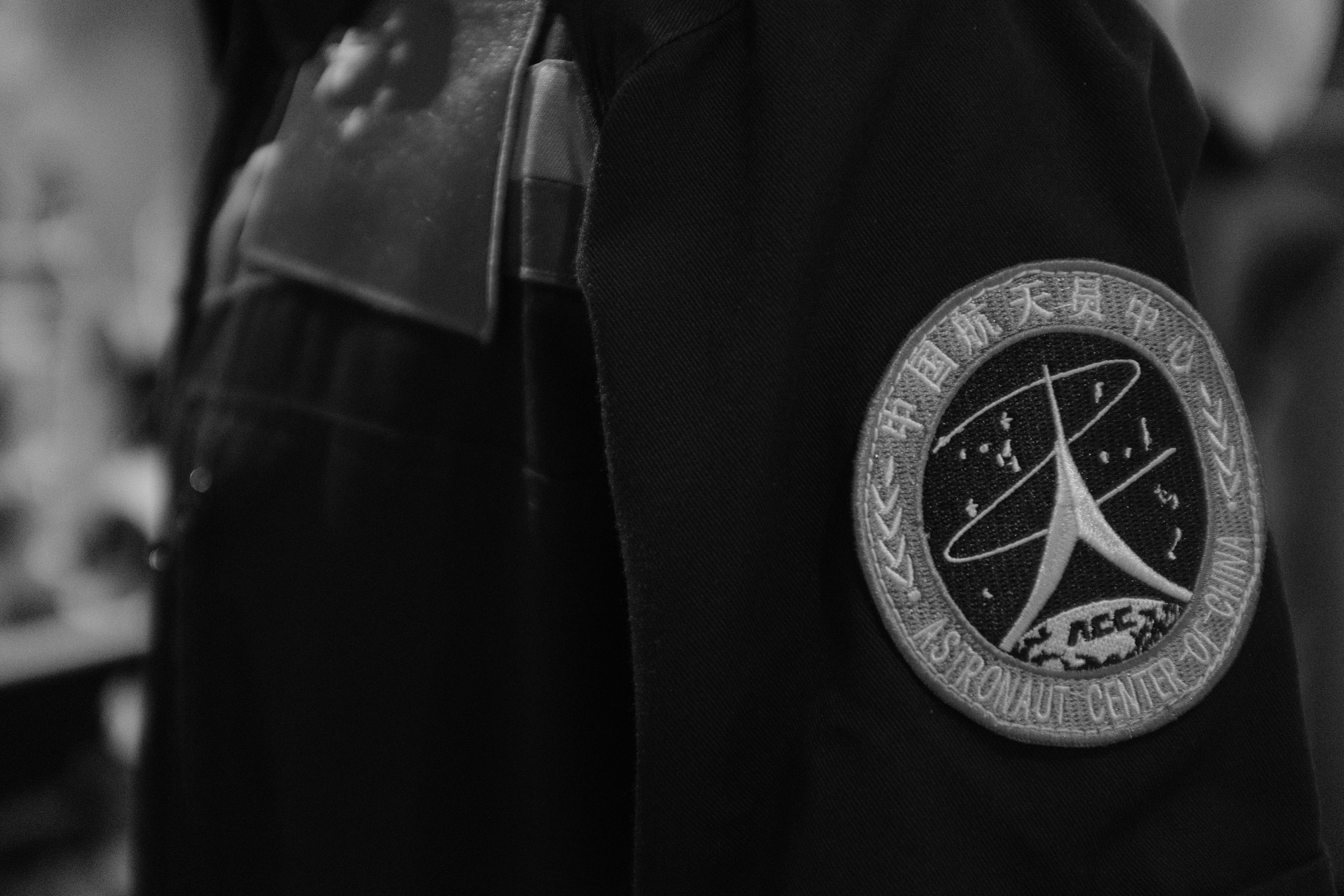 A patch of the chinese space program is visible. photo – Free Man Image ...
