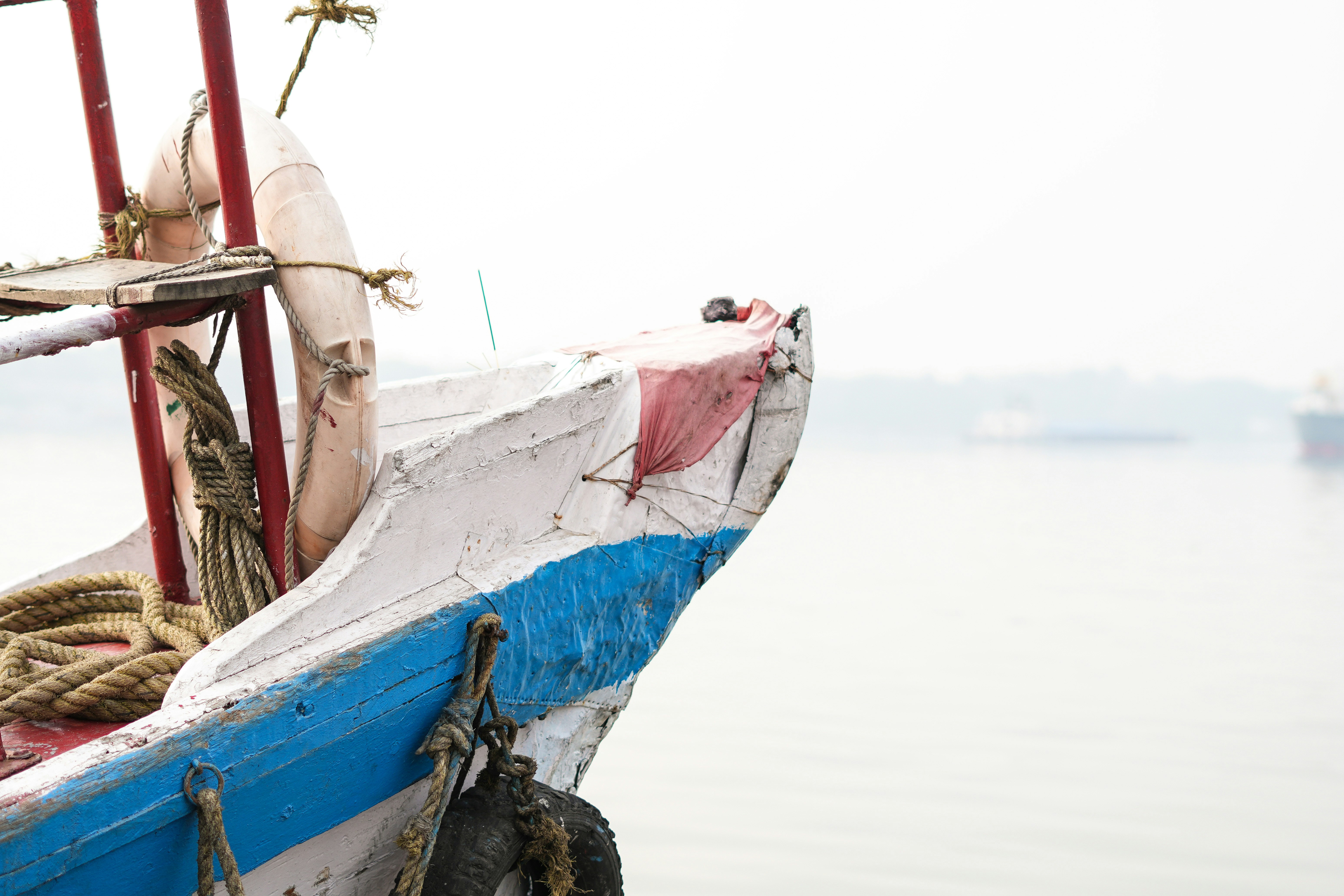 Weathered Bow, Blue Stripe, and Ropes: A Quiet Mooring Portrait