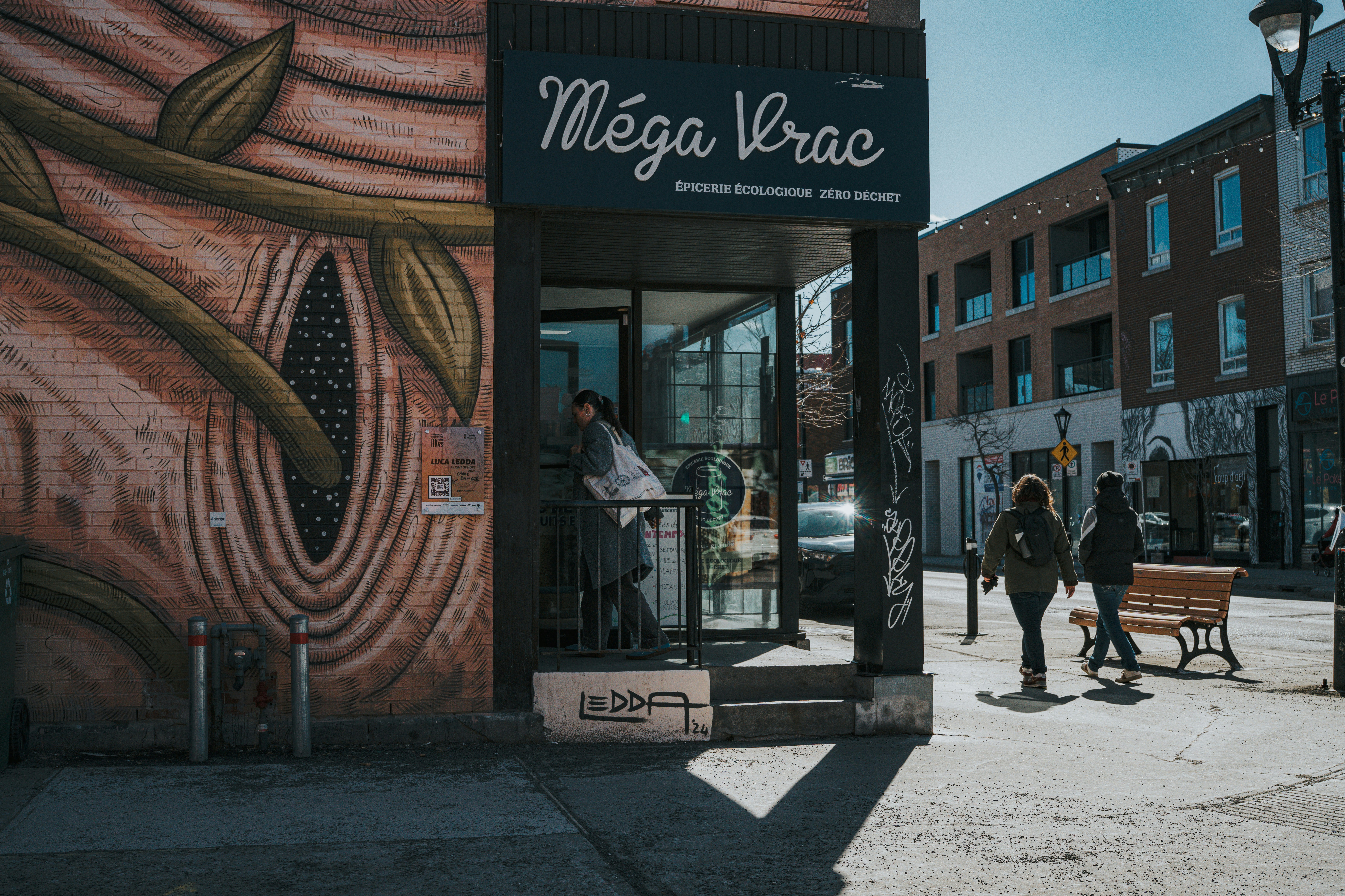 A storefront with graffiti, people, and a street. photo – Free Car ...