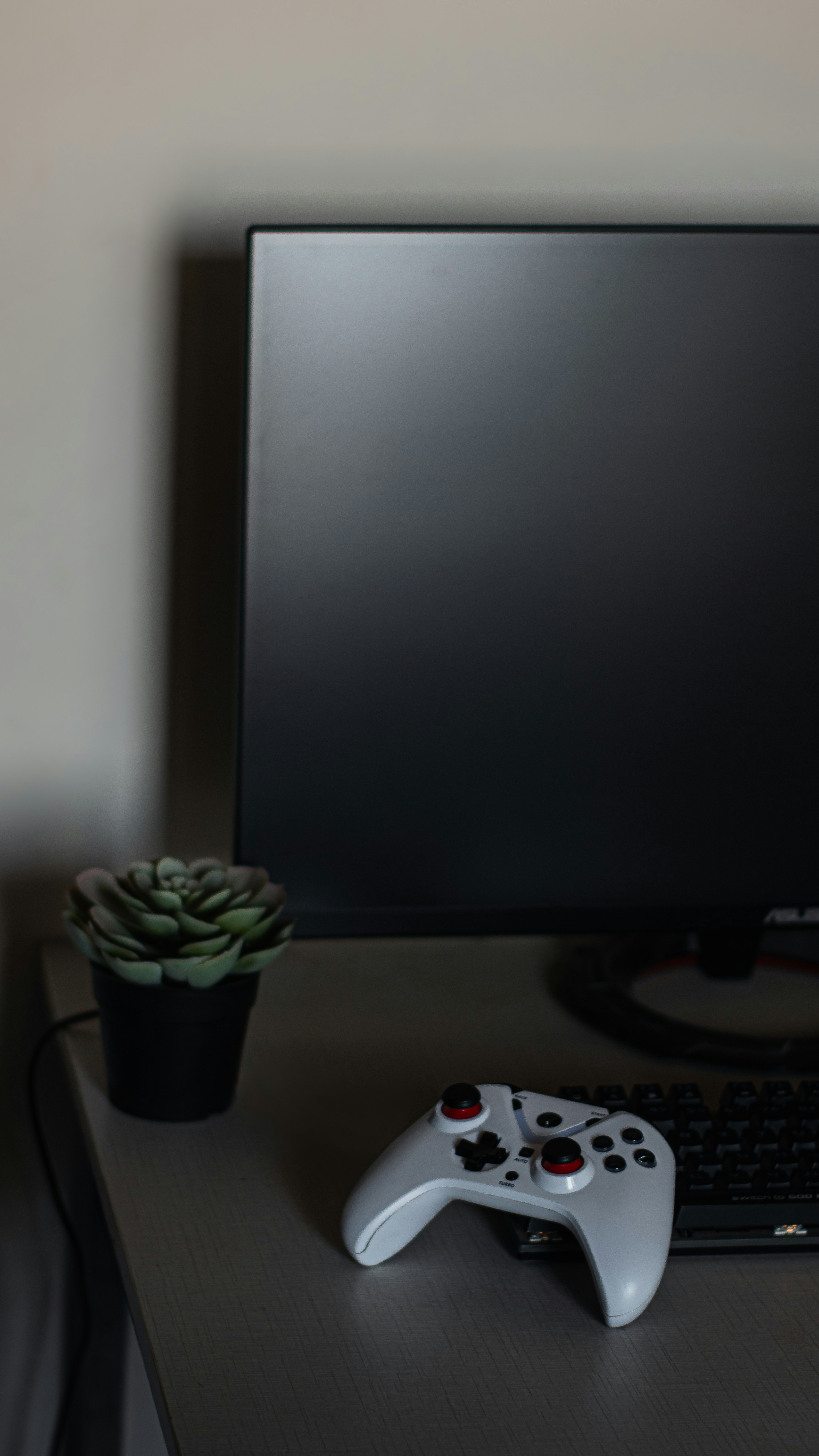 A gaming setup with a controller and monitor.