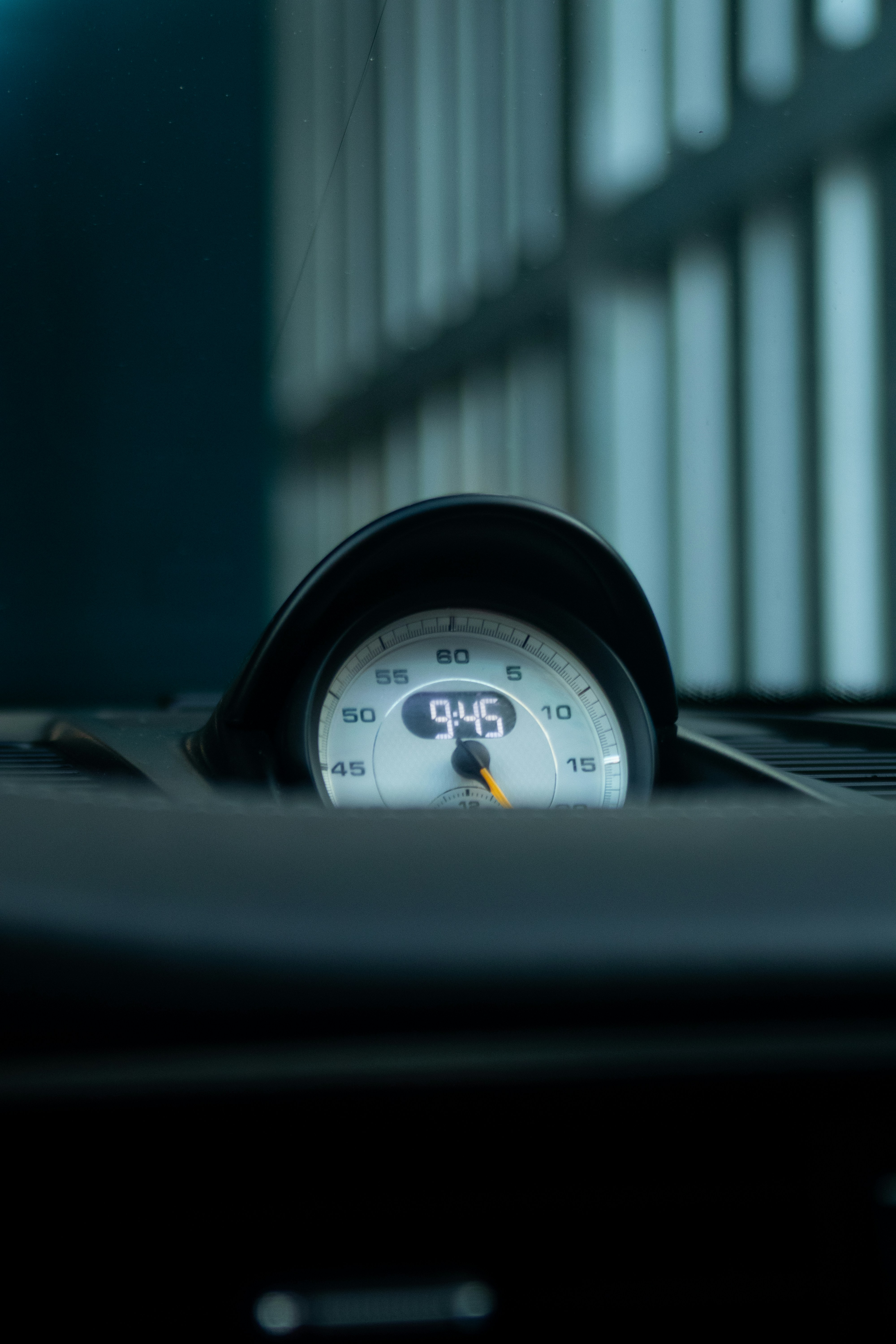 Clockwork Pause: A Dashboard Dial Bathed in Blue Ambient Light