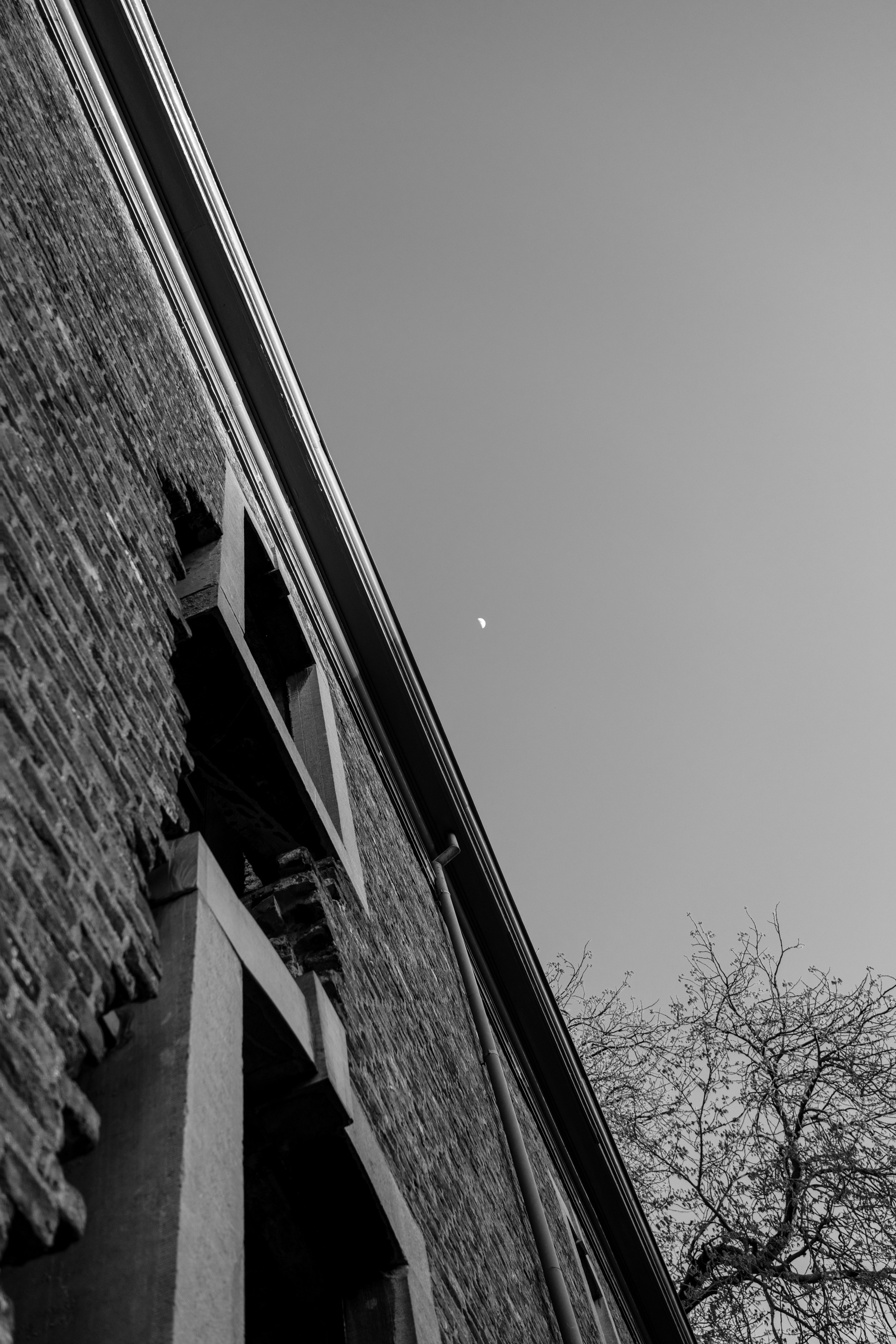 Moonlit Diagonal: Brick Facade Under a Quiet Sky