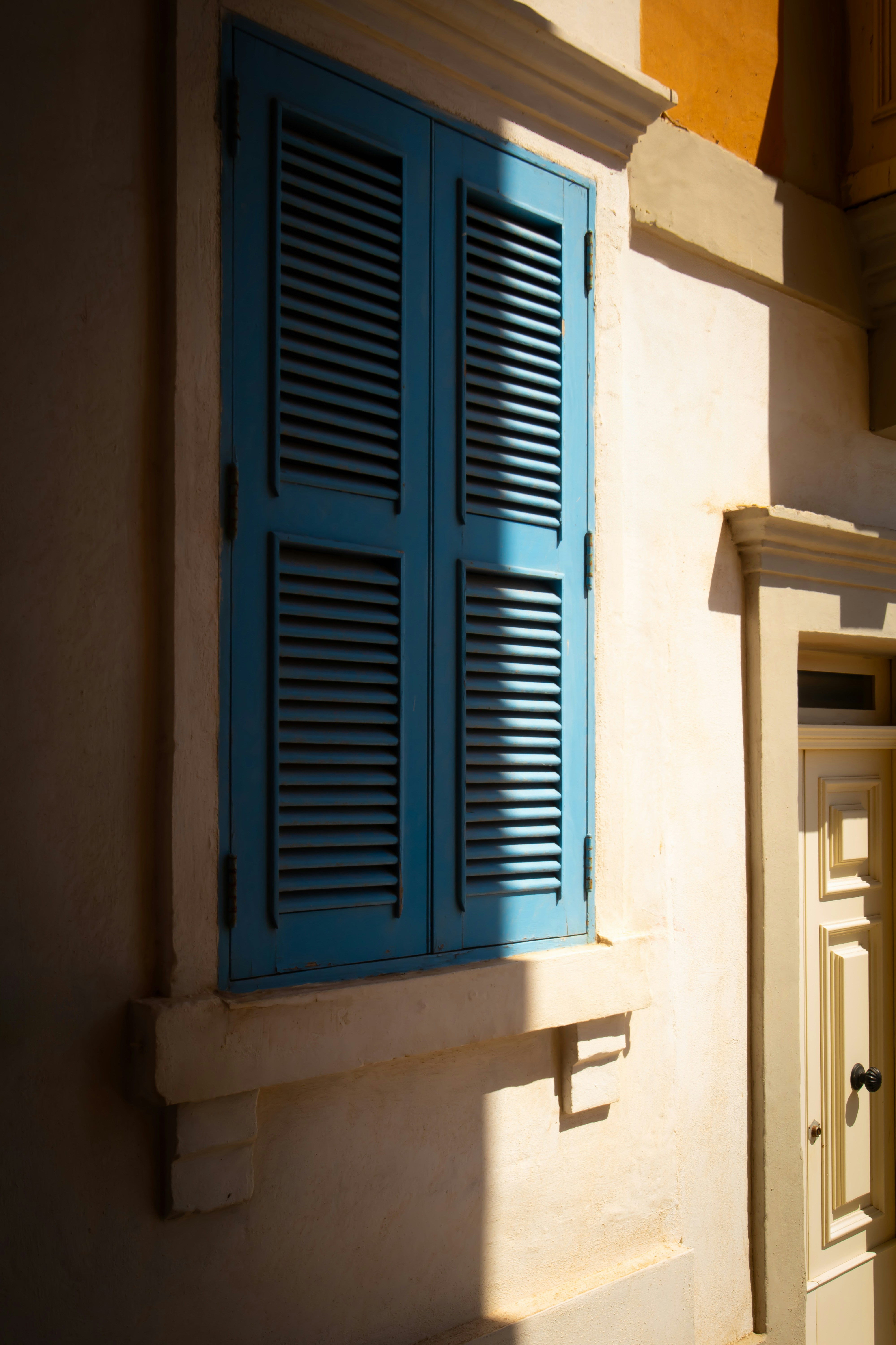 Blue shutters on a cream-colored building. photo – Free Blue Image on ...
