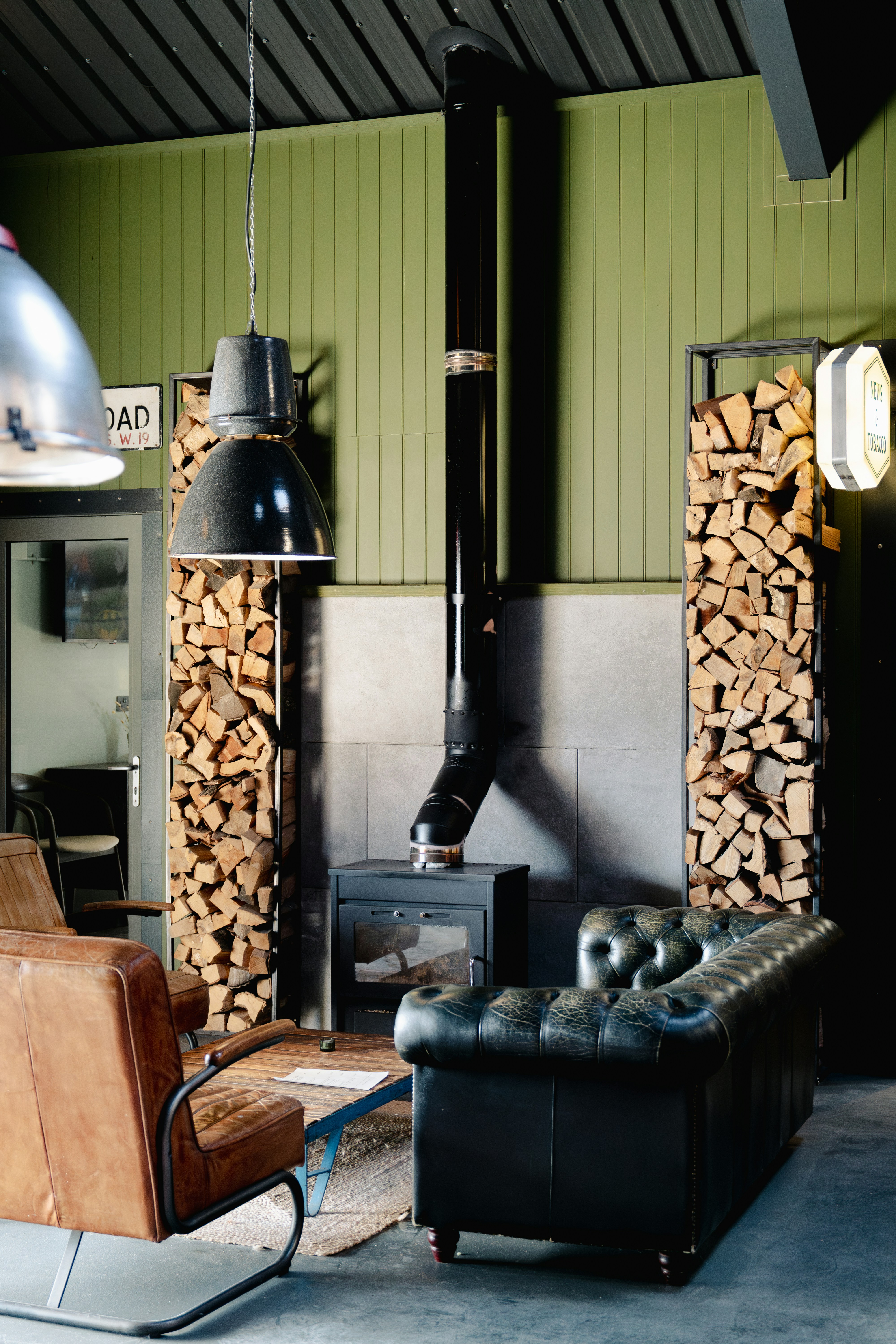 A cozy lounge features a fireplace and firewood stacks. photo – Free ...