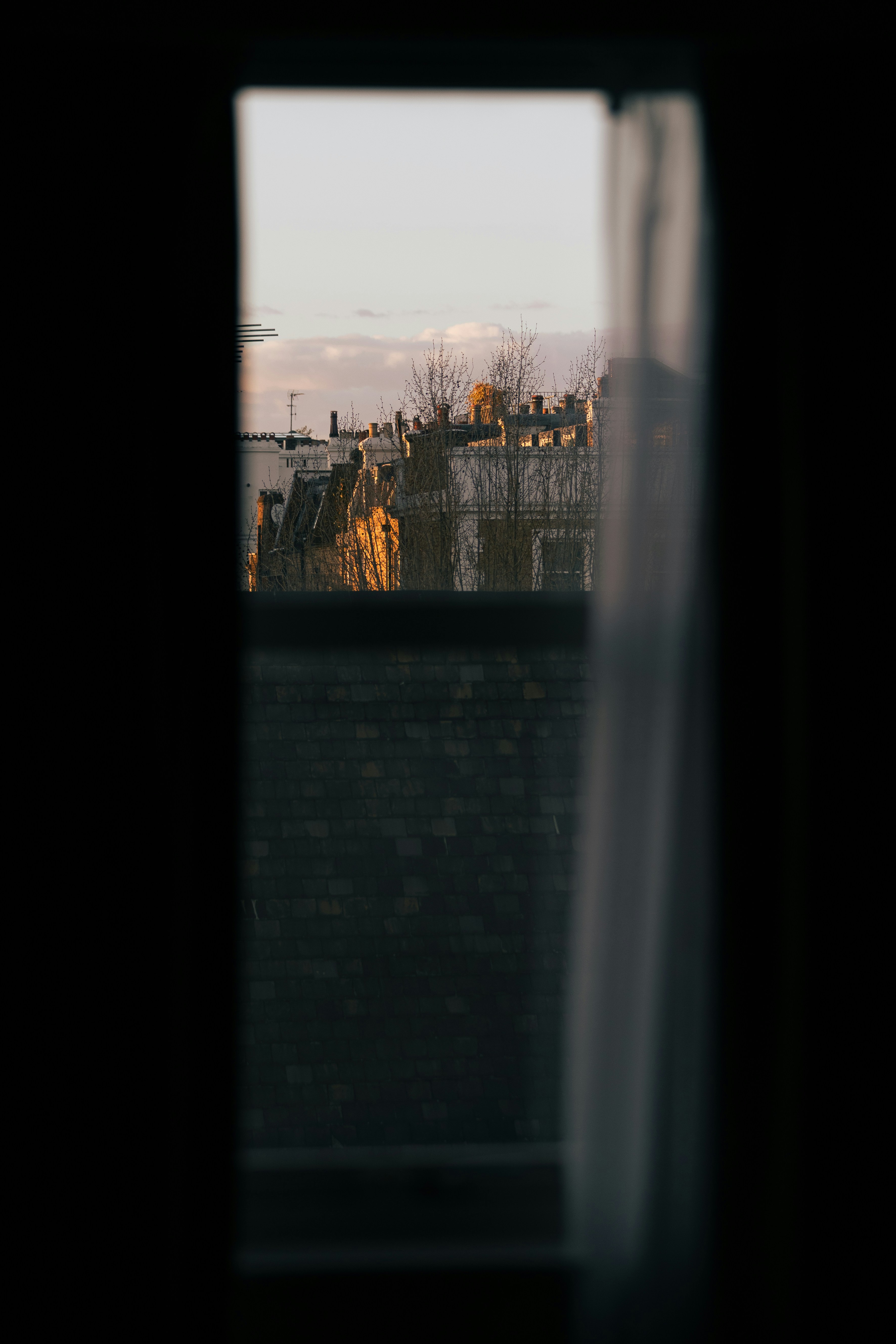 Rooftops are seen through a window's frame. photo – Free Window Image ...