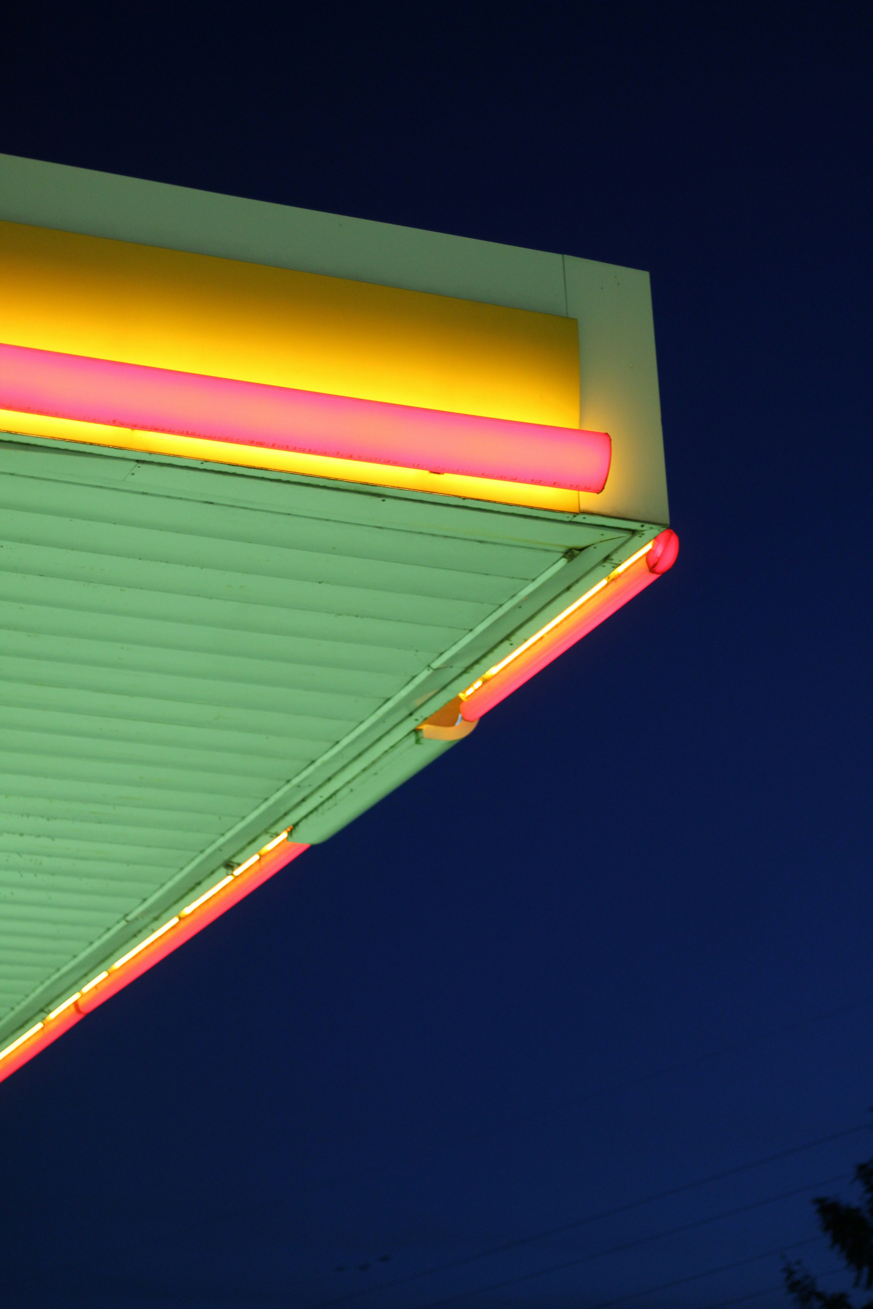 Neon sign glows against a dark night sky. photo – Free Night Image on ...