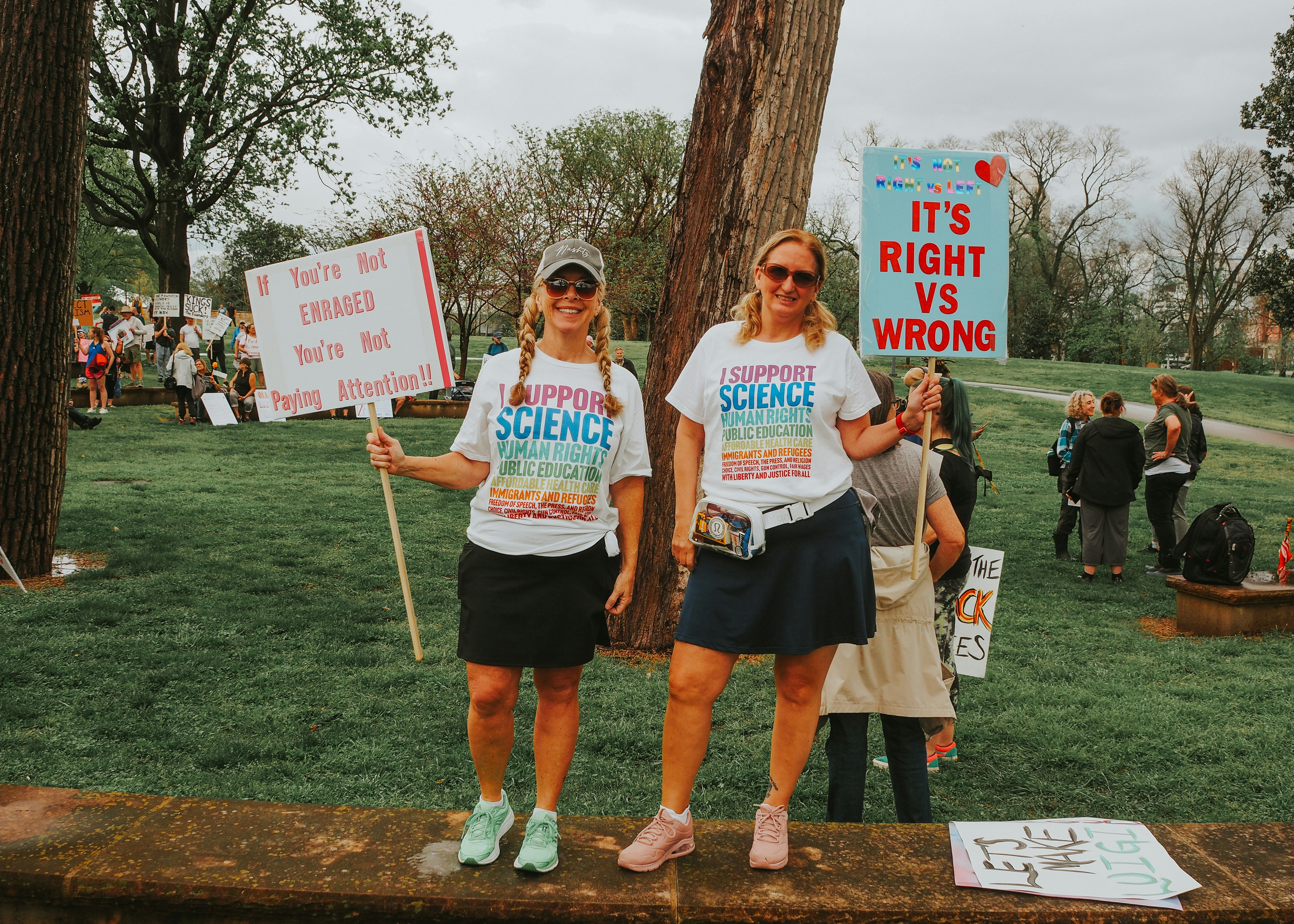 People protest with signs, supporting science and right versus wrong ...