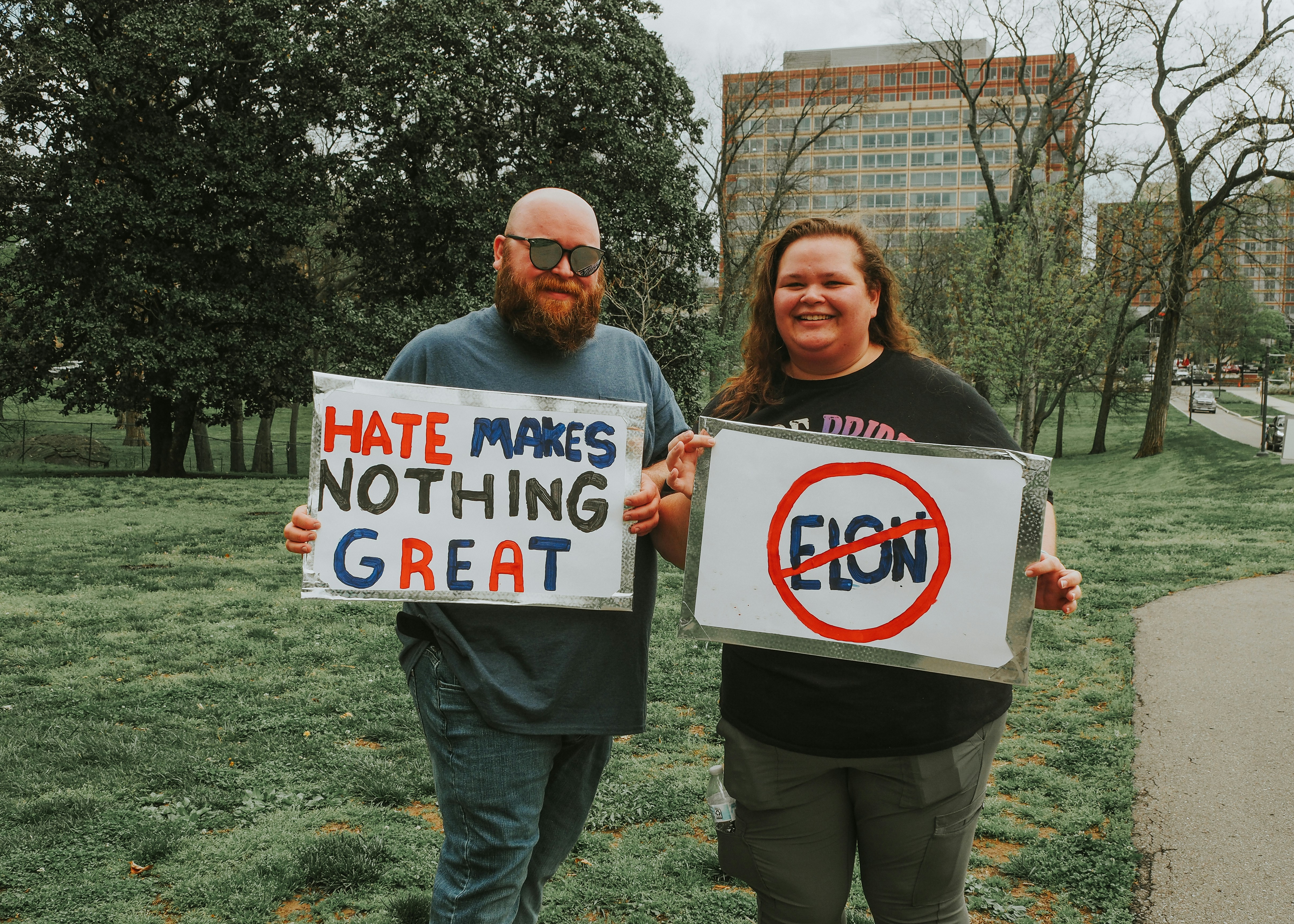 Protesters hold signs with anti-hate and anti-elon messages. photo ...