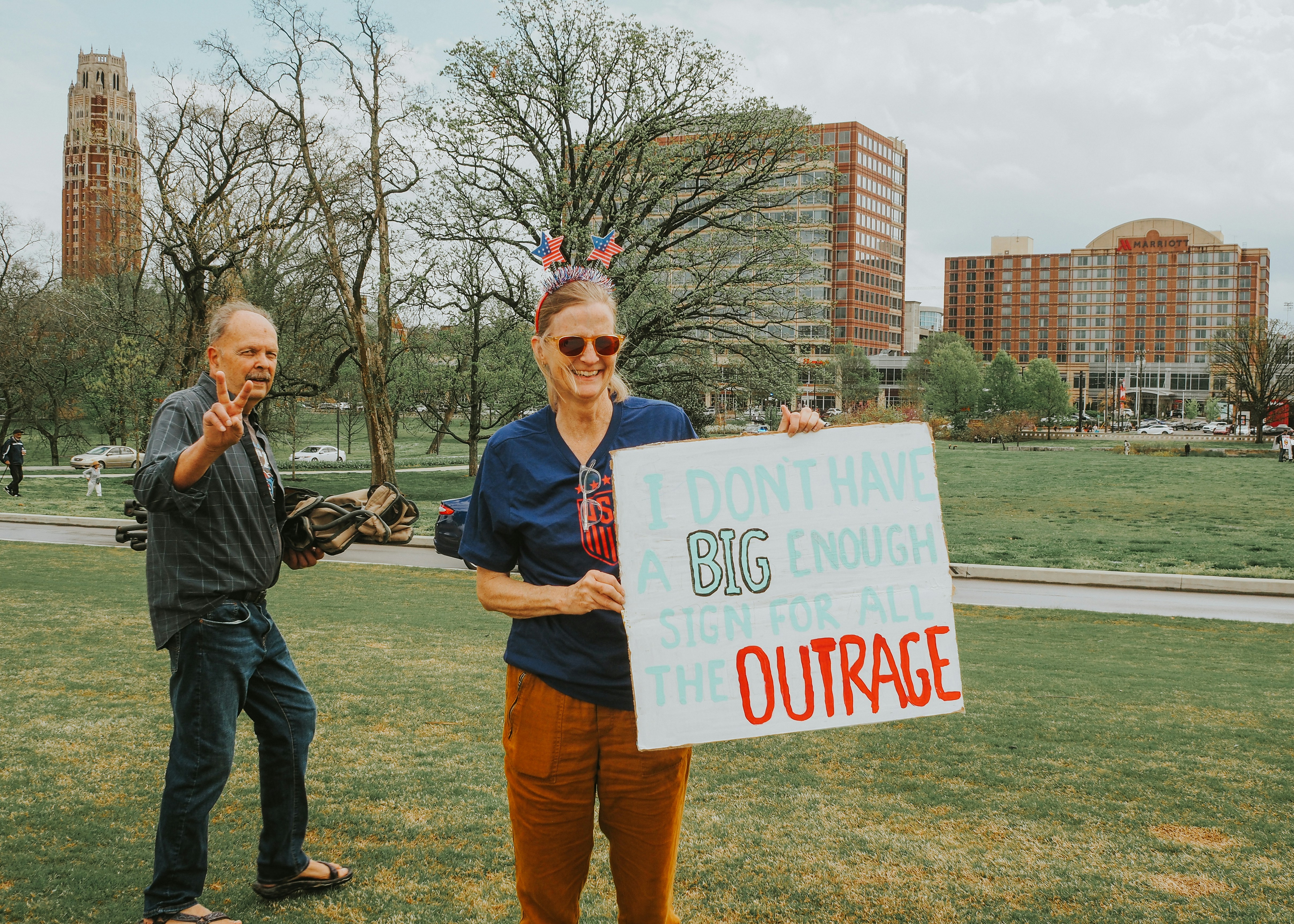 Woman protests with a sign about outrage. photo – Free Car Image on ...