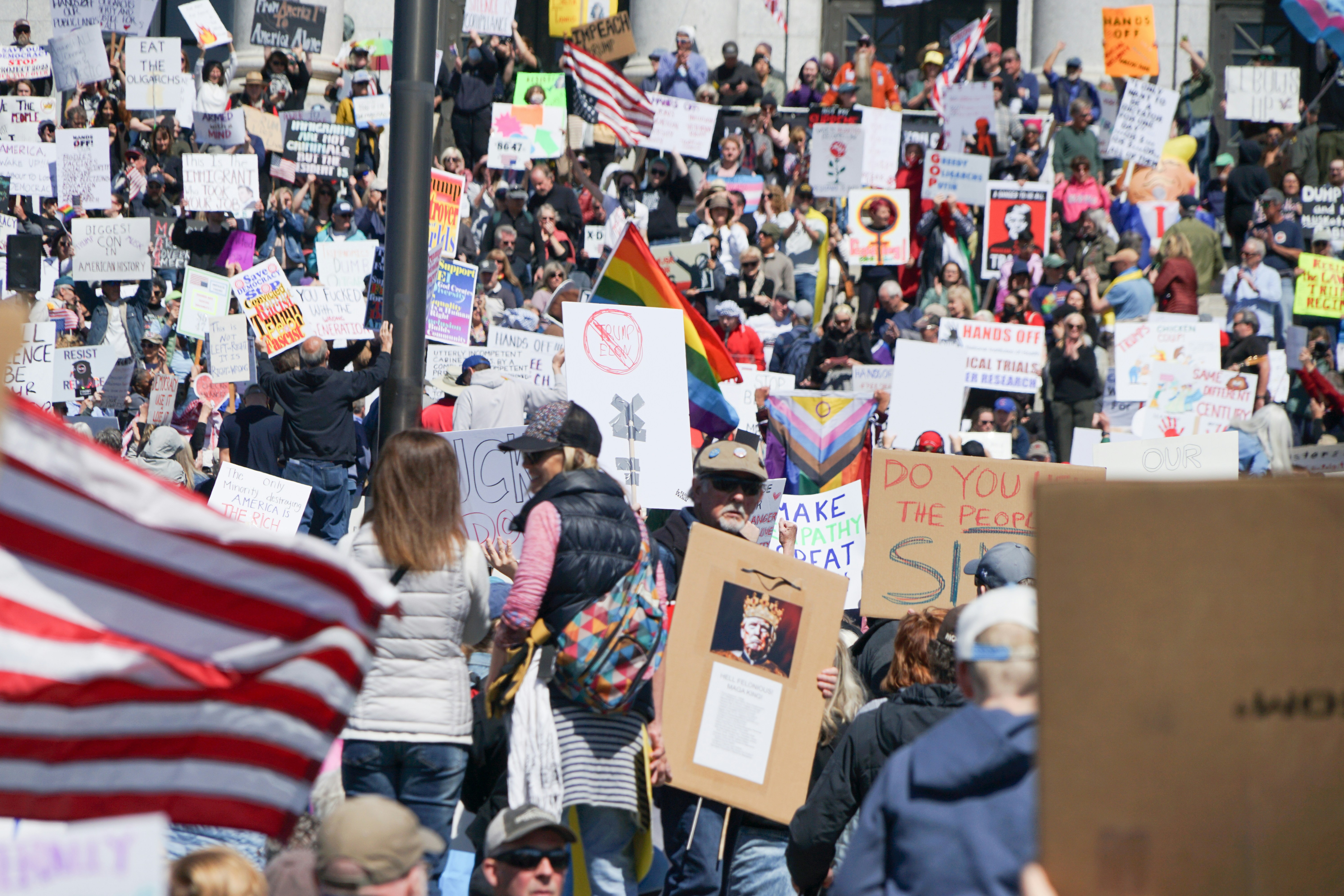 Protesters march in a large crowd with signs. photo – Free Woman Image ...