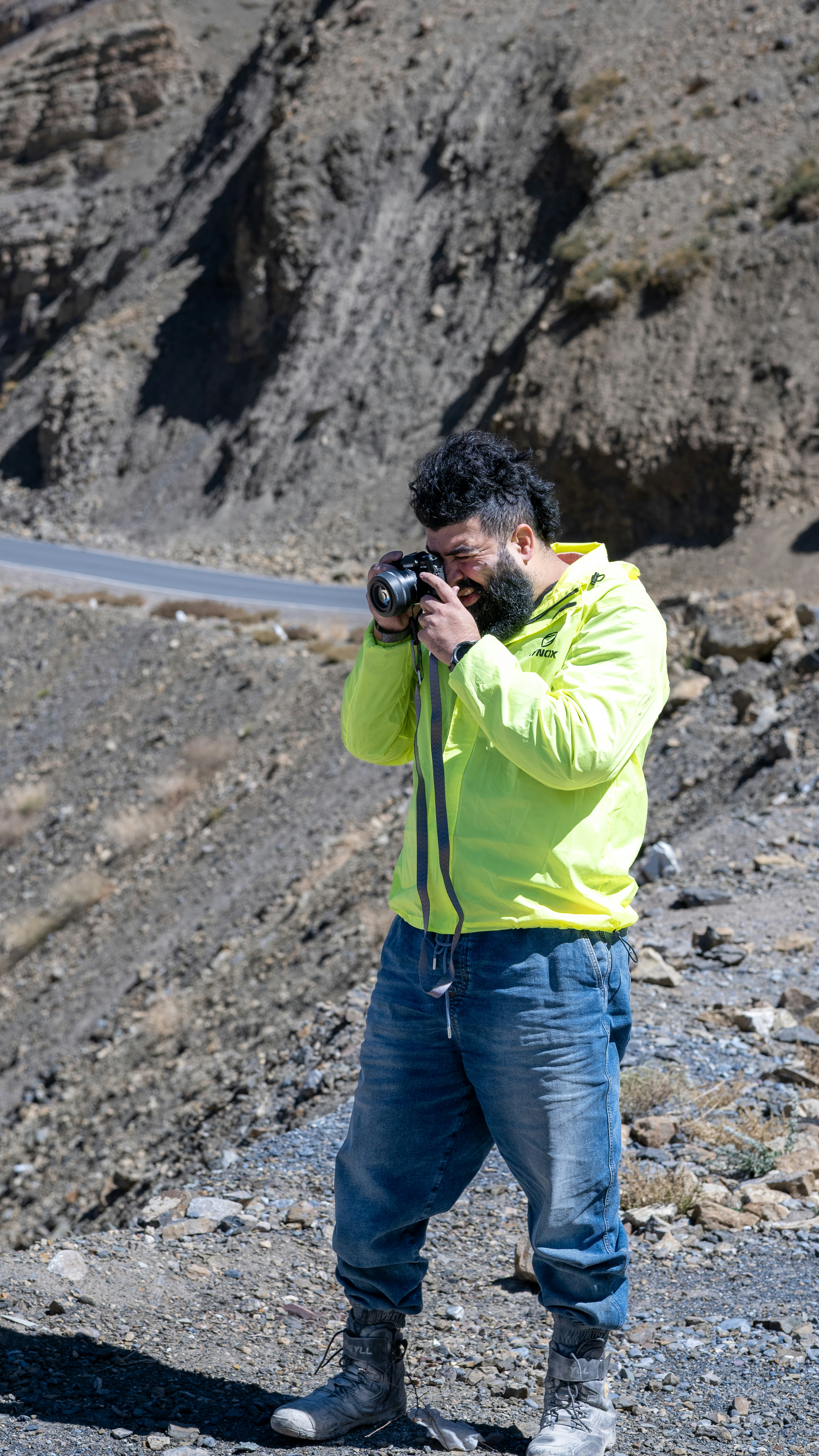 Neon Jacket, Quiet Lens: A Photographer Capturing the Cliffside Terrain